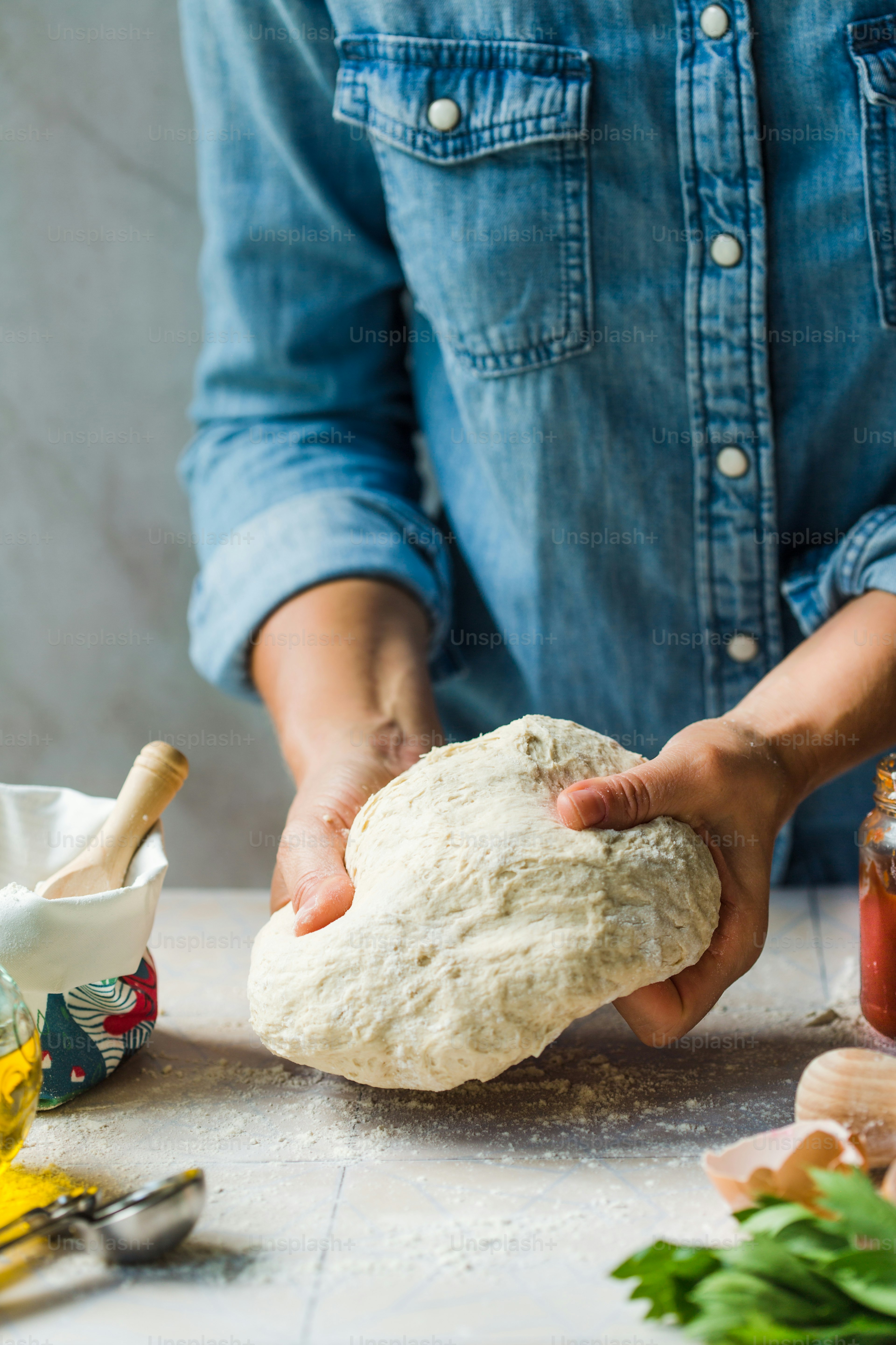A person kneading a ball of bread on top of a counter photo – Food ...
