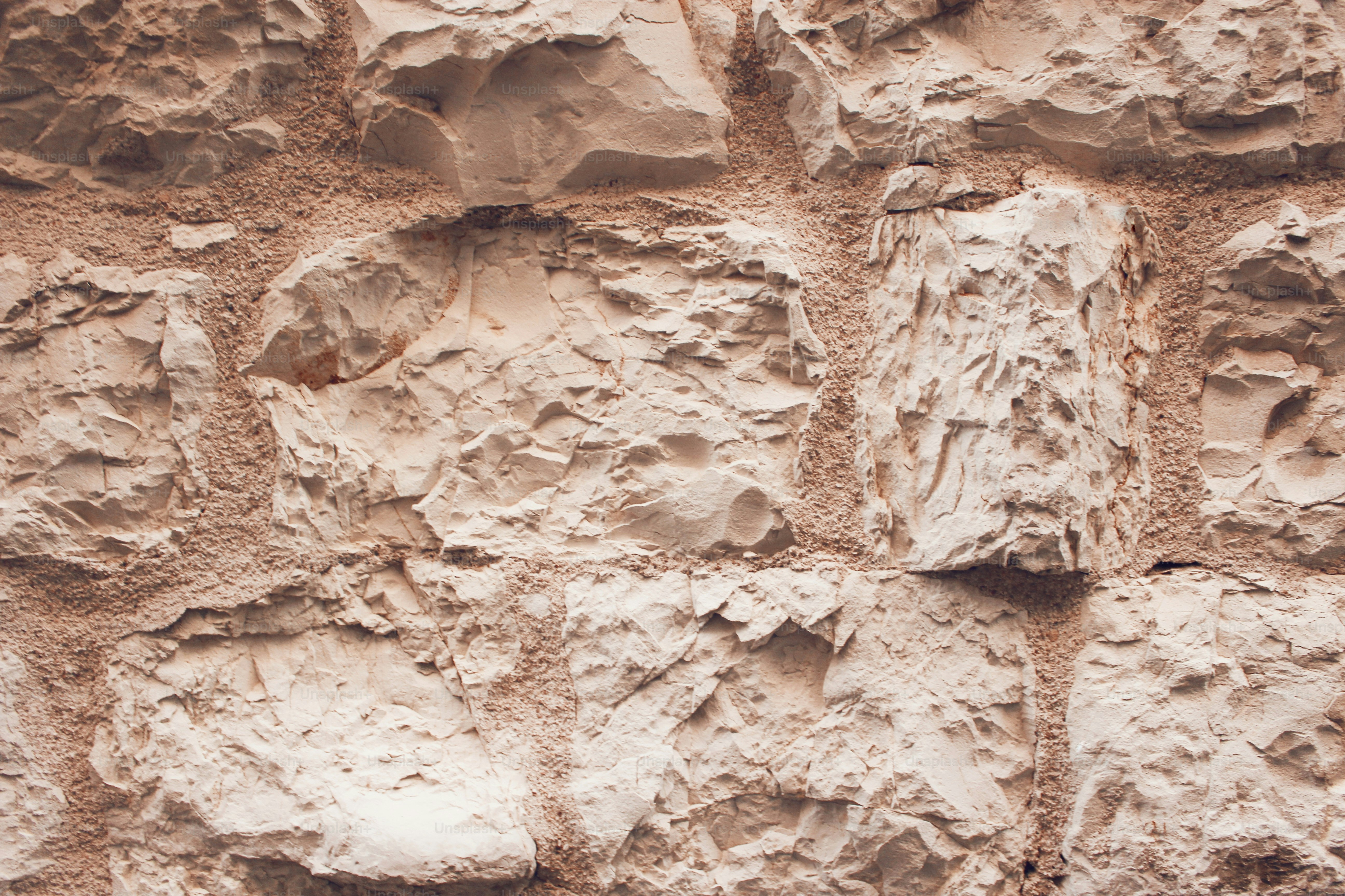 A close up of a wall made of rocks photo – Neutral Image on Unsplash