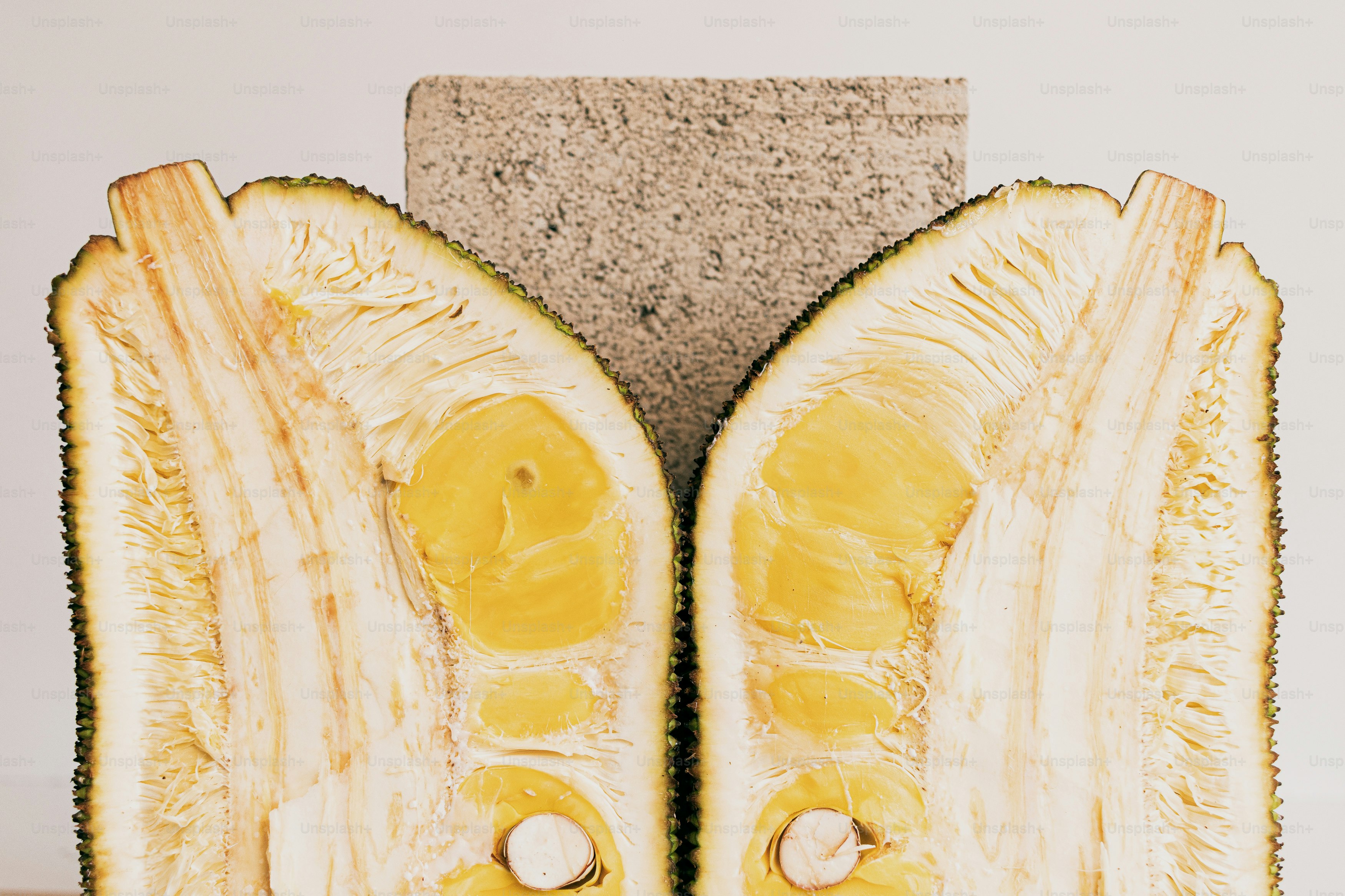 A couple of slices of fruit sitting on top of a table photo – Texture ...