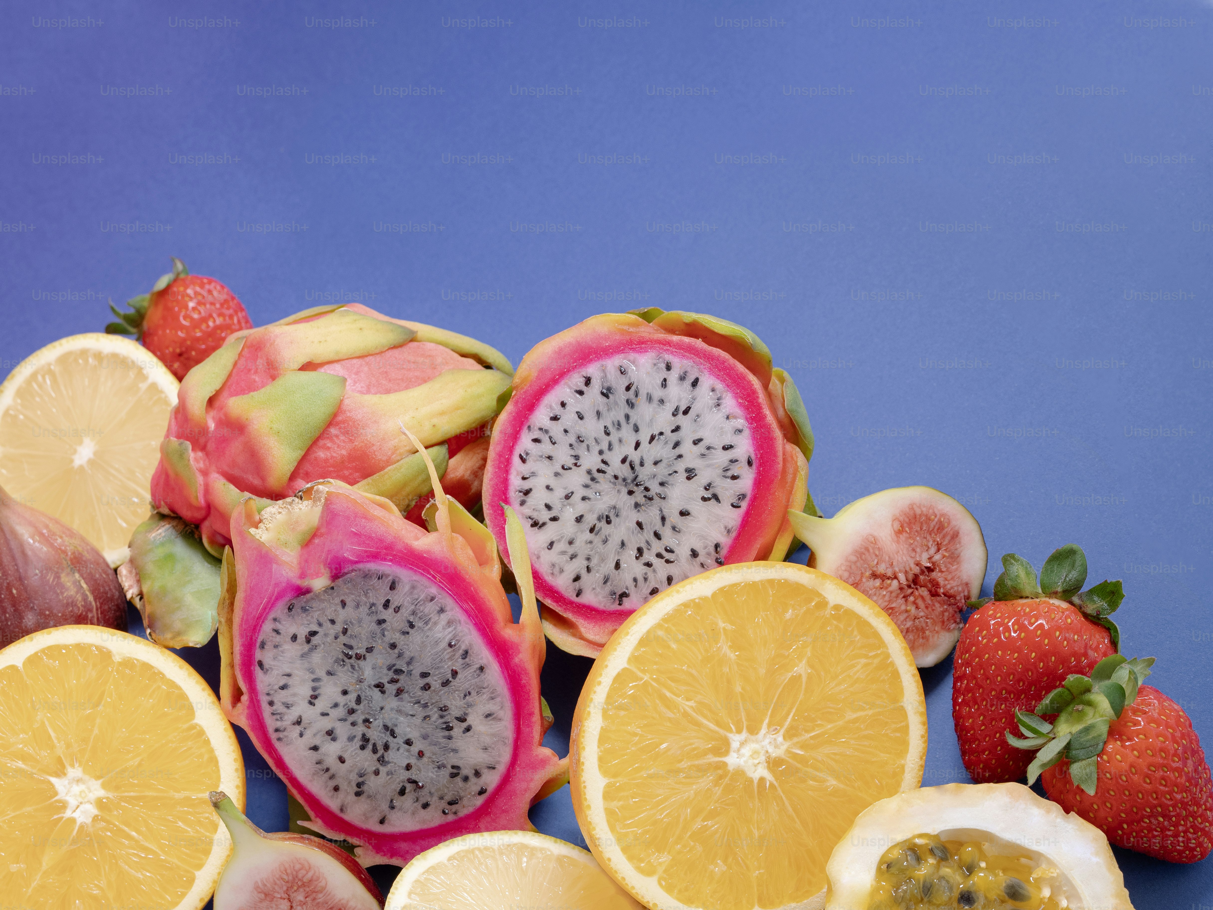 A pile of cut up fruit sitting on top of a table photo – Dragon fruit ...