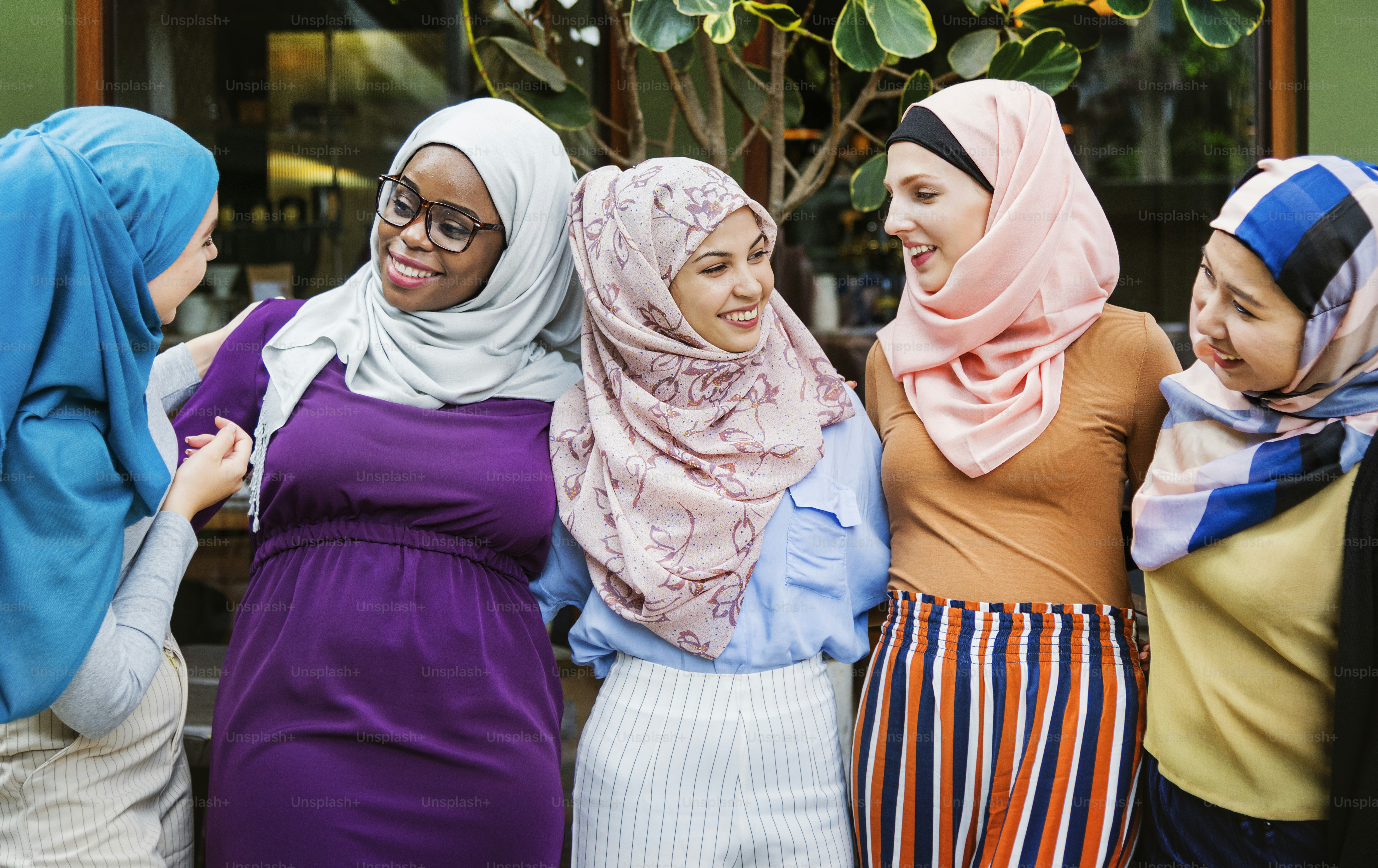 Group of islamic friends arms around and smiling together photo ...