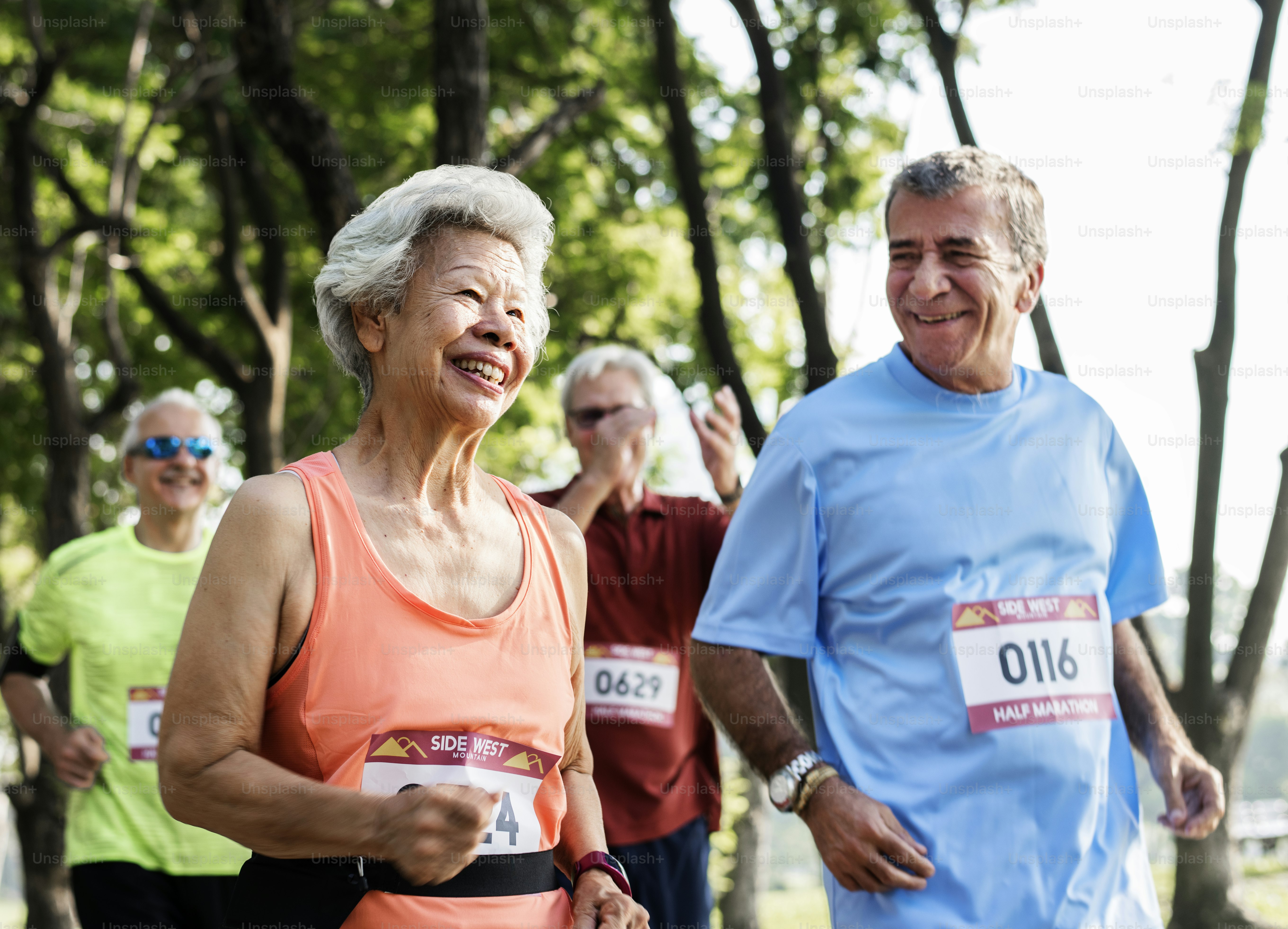 Happy senior running through the finish line photo – Adult Image on ...
