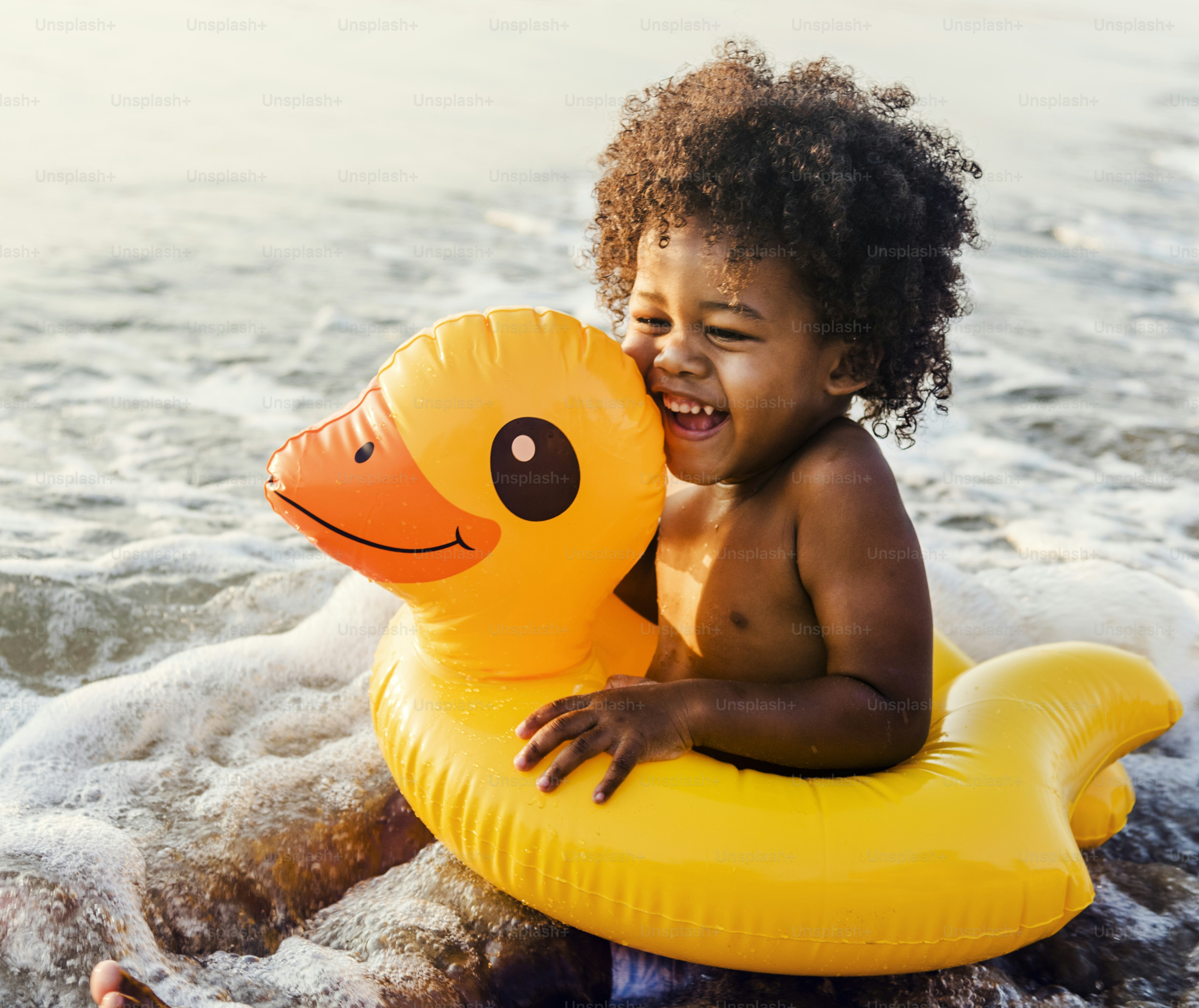 Cute toddler with duck tube on the beach photo – Beach Image on Unsplash