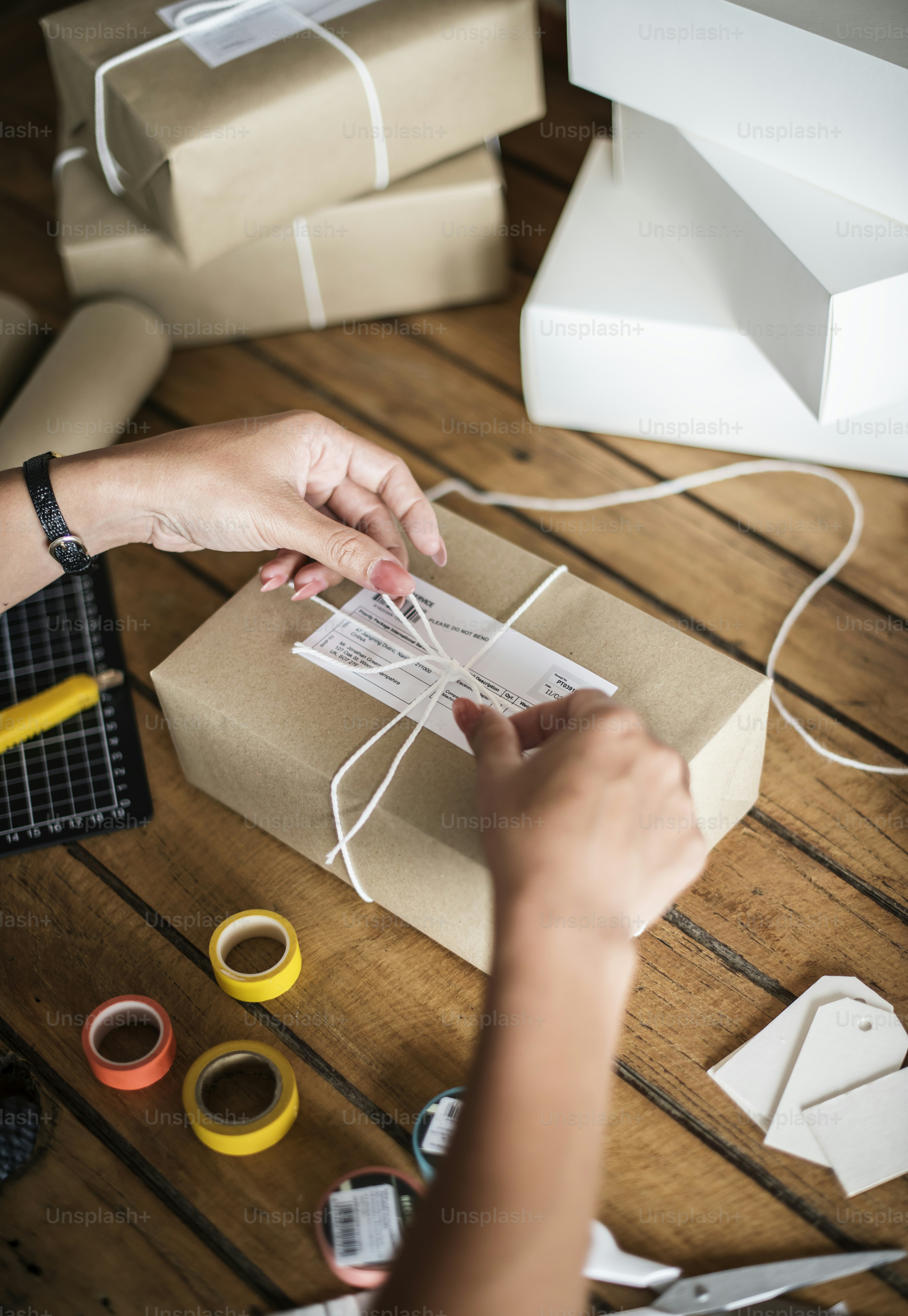 Woman packing parcels ***These documents are our own generic designs ...