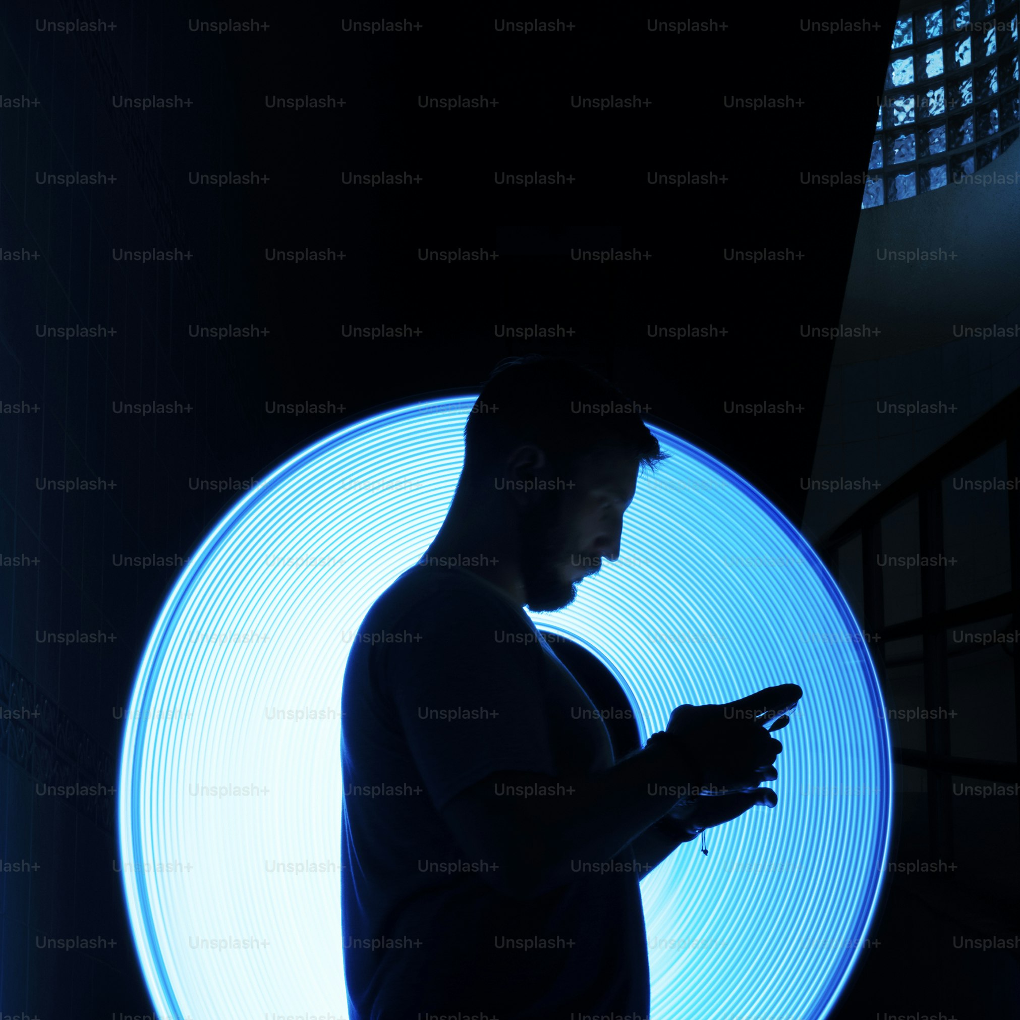 Closeup of a man using mobile phone in the dark with long exposure ...