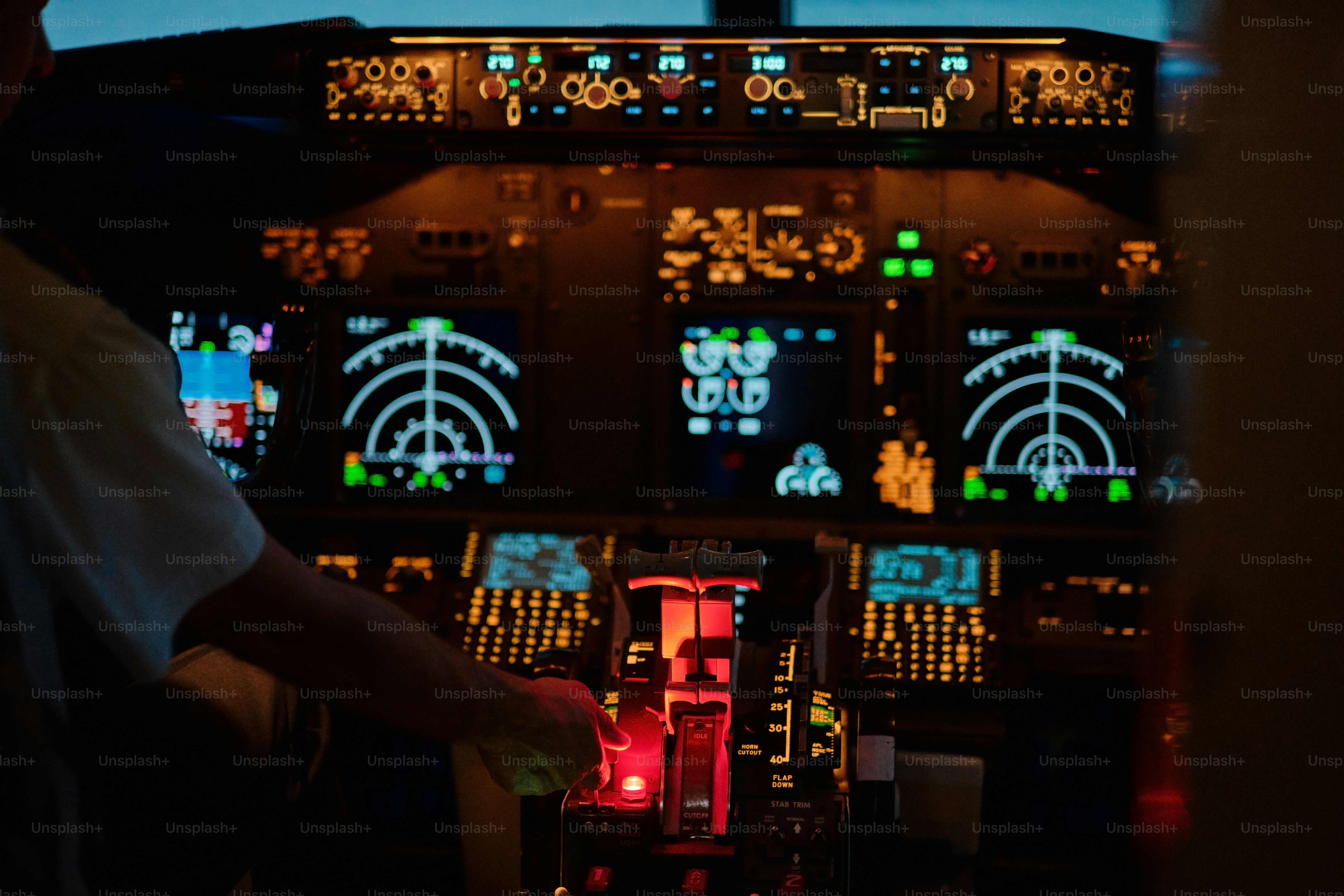 Two pilots in the cockpit of a plane at night photo – Travel Image on ...