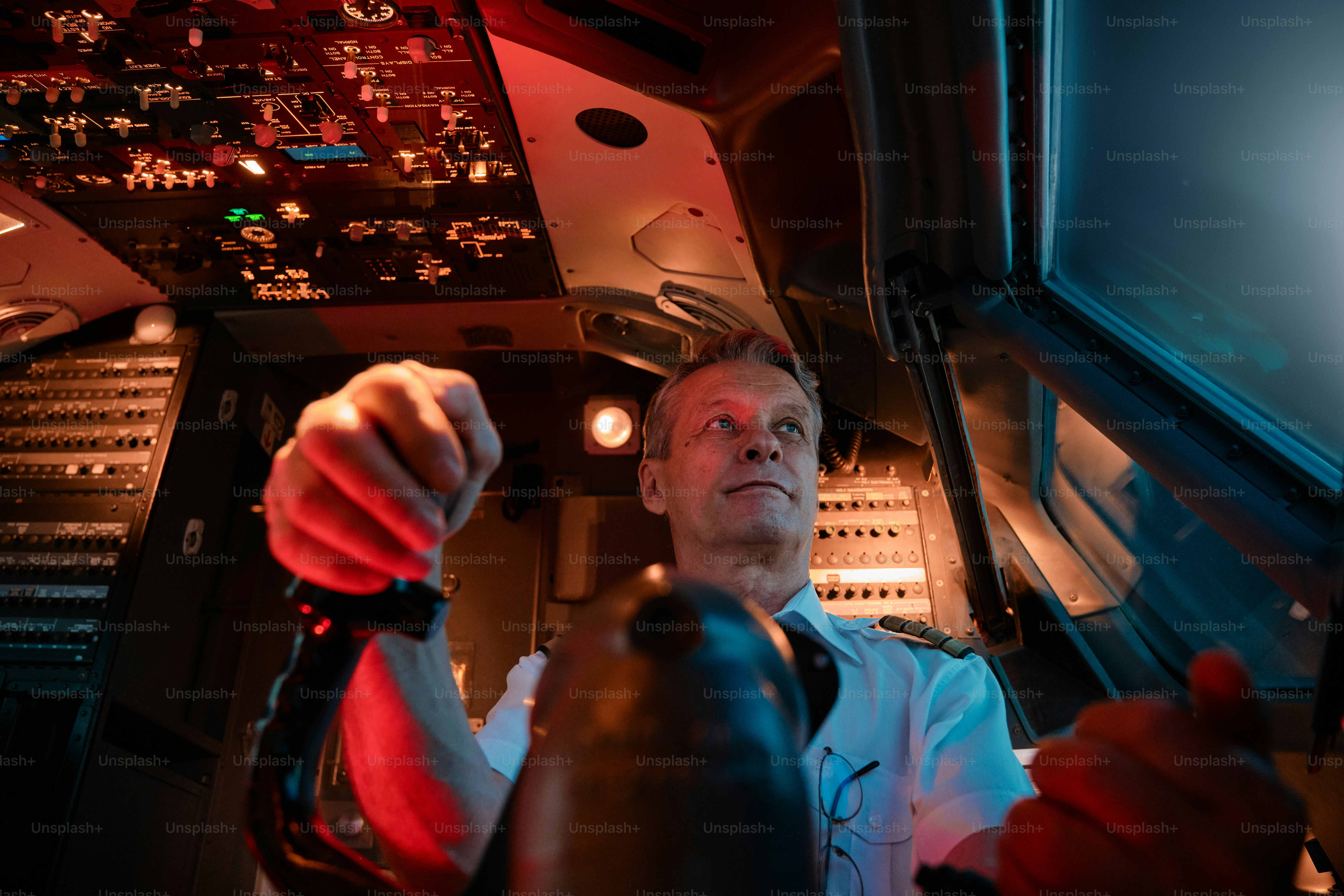 A man sitting in the cockpit of a plane photo – Air travel Image on ...