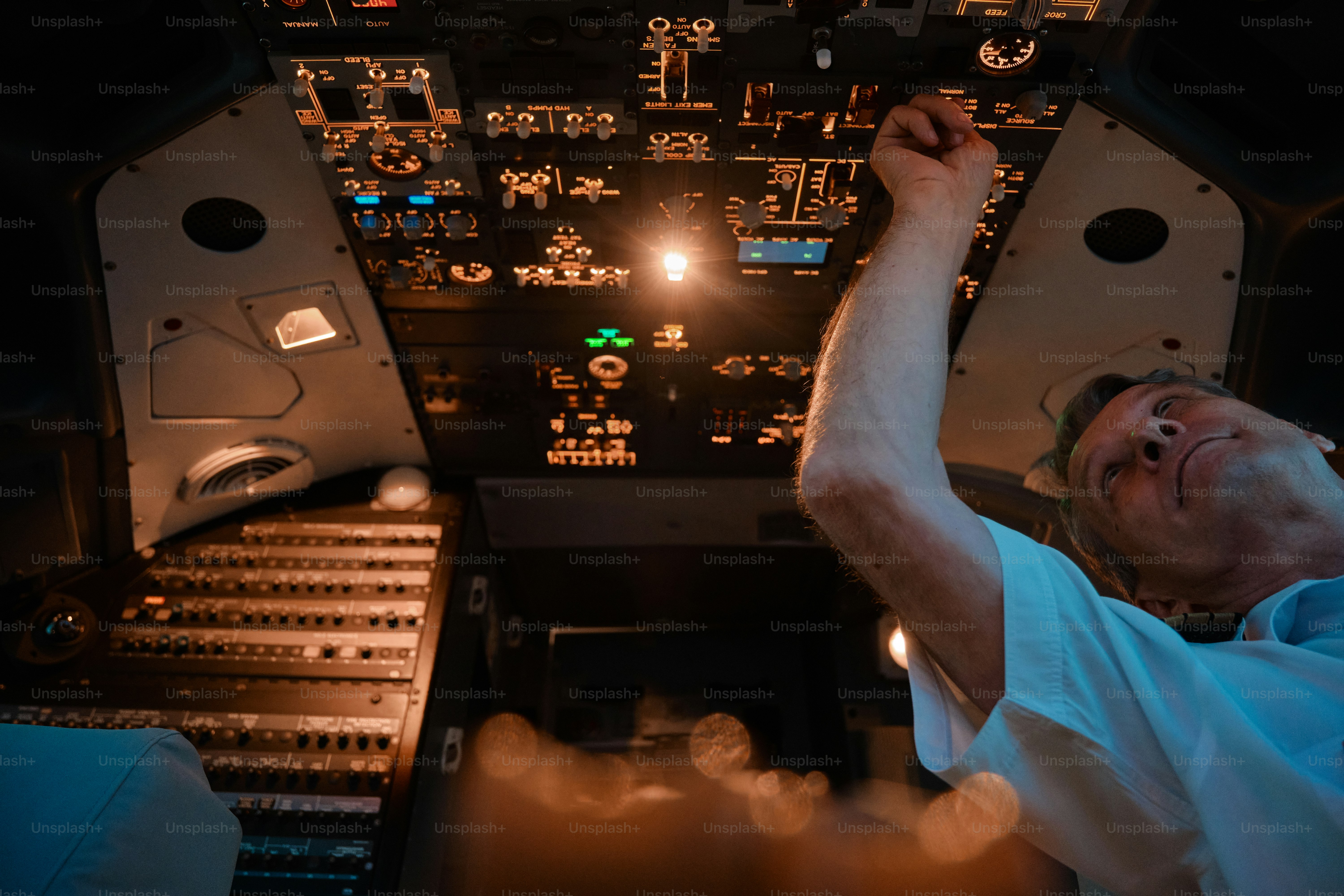 A man in the cockpit of an airplane photo – Air travel Image on Unsplash
