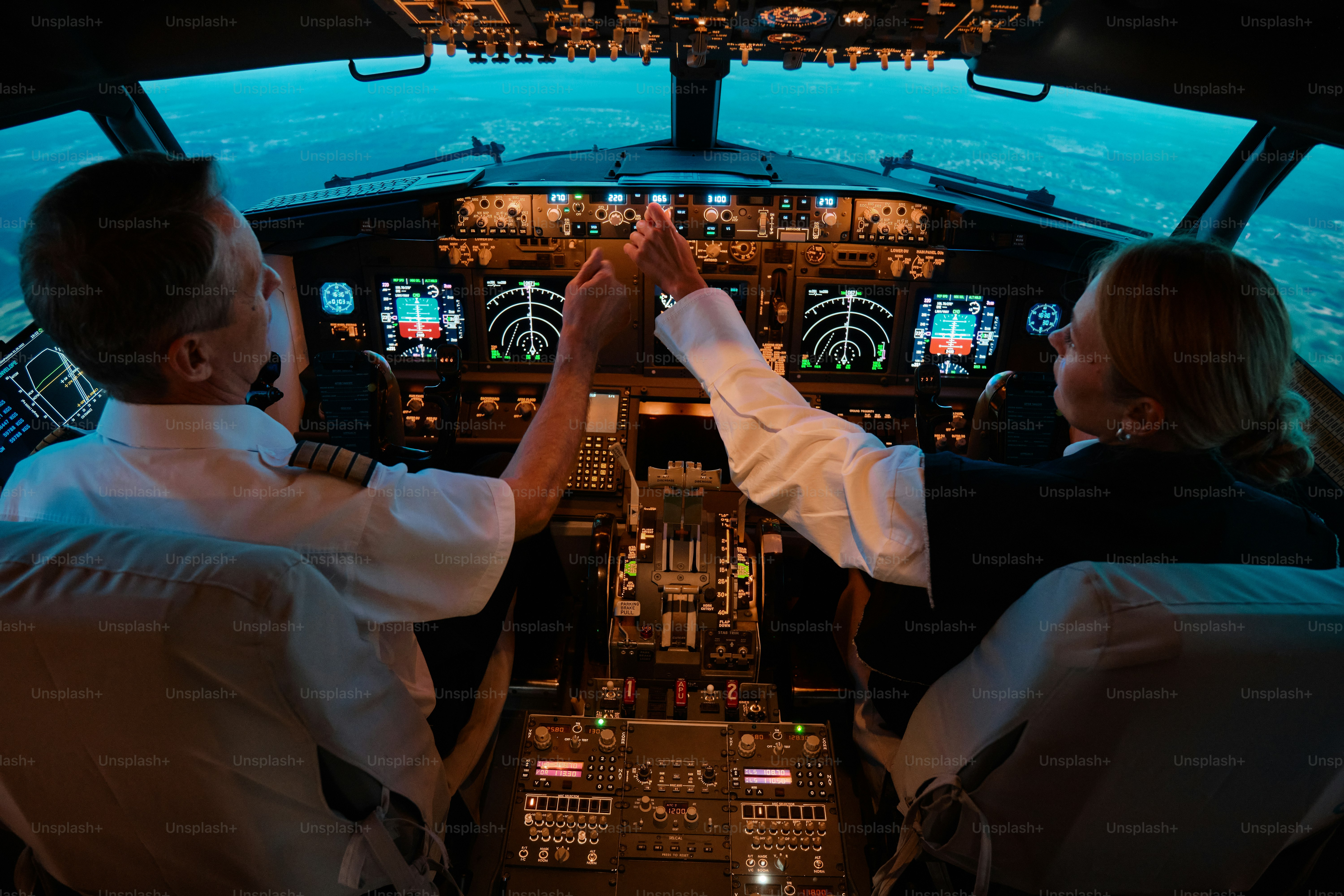 A couple of people that are sitting in a plane photo – Air travel Image ...