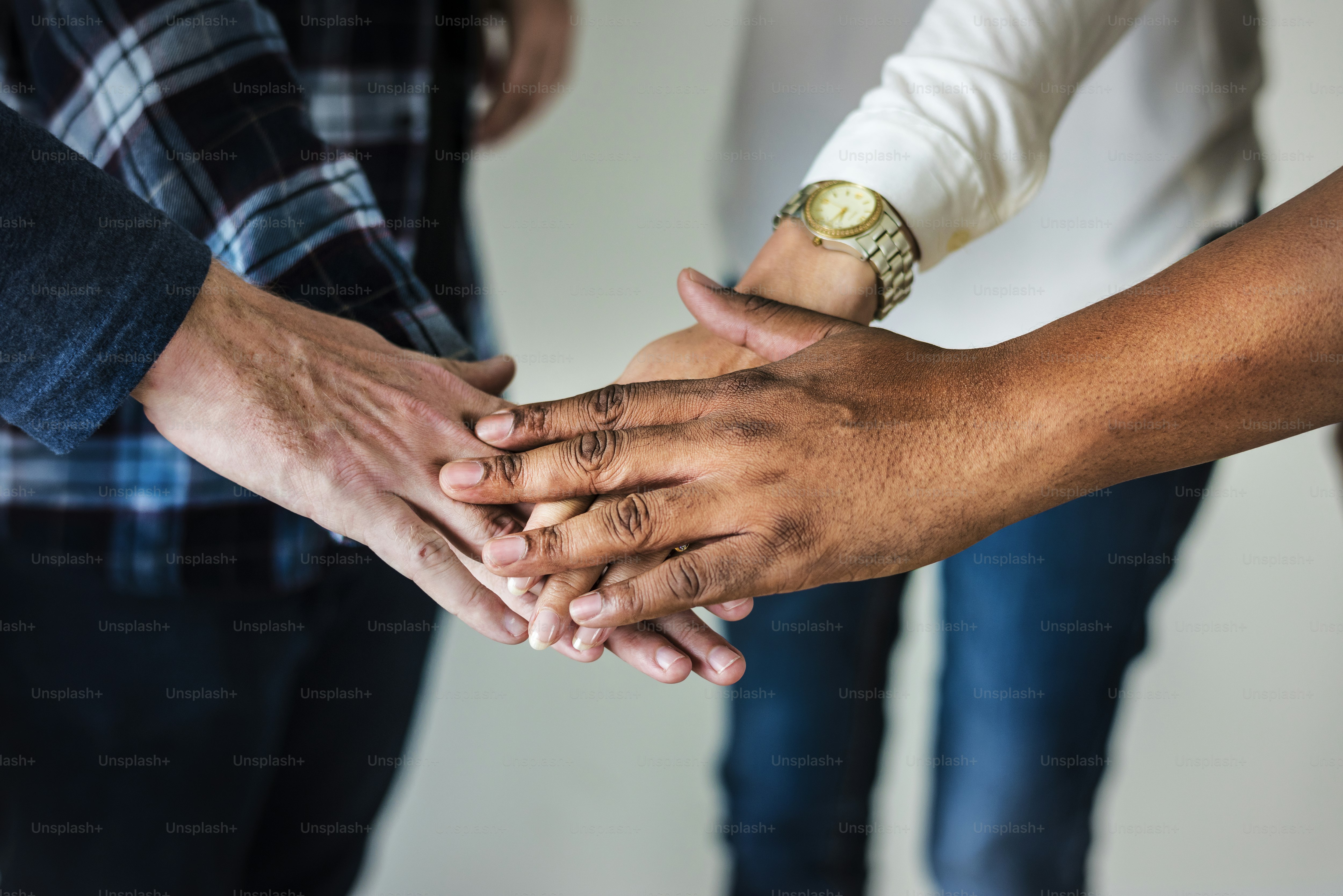 Diverse people joining hands together teamwork and community concept ...