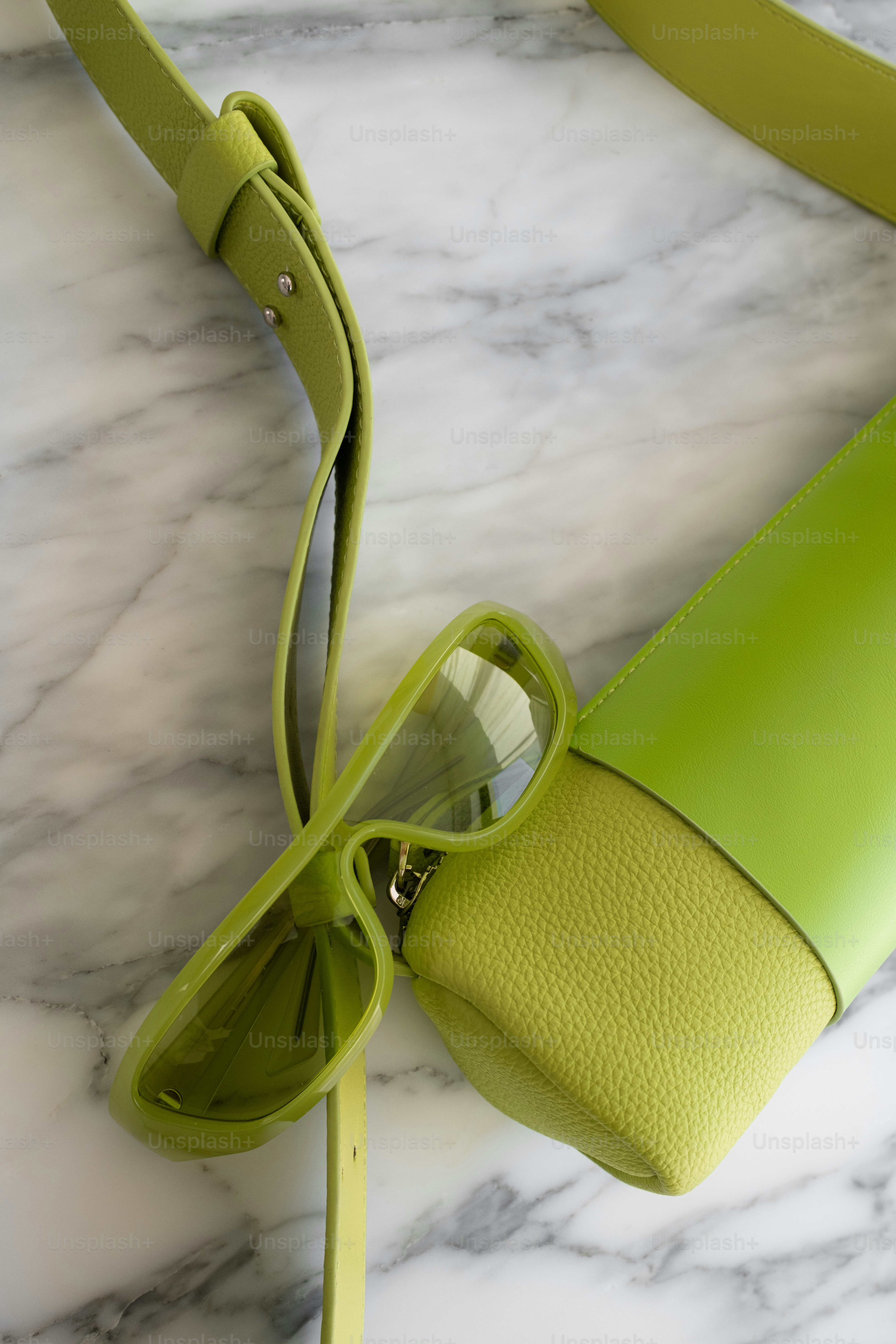 A green purse sitting on top of a marble counter photo – Lime green ...