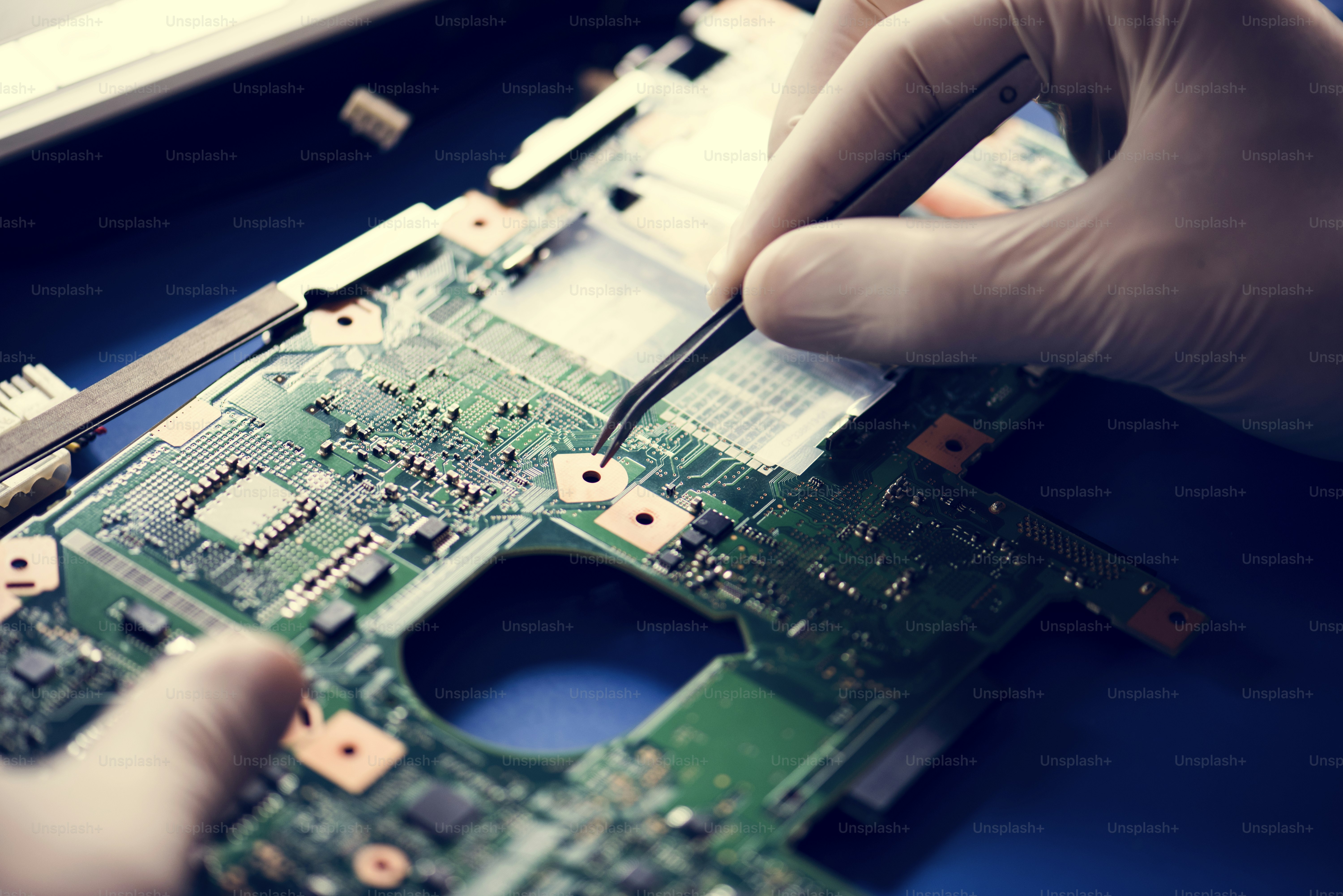 Closeup of hands with computer motherboard and tweezers photo – Hand ...