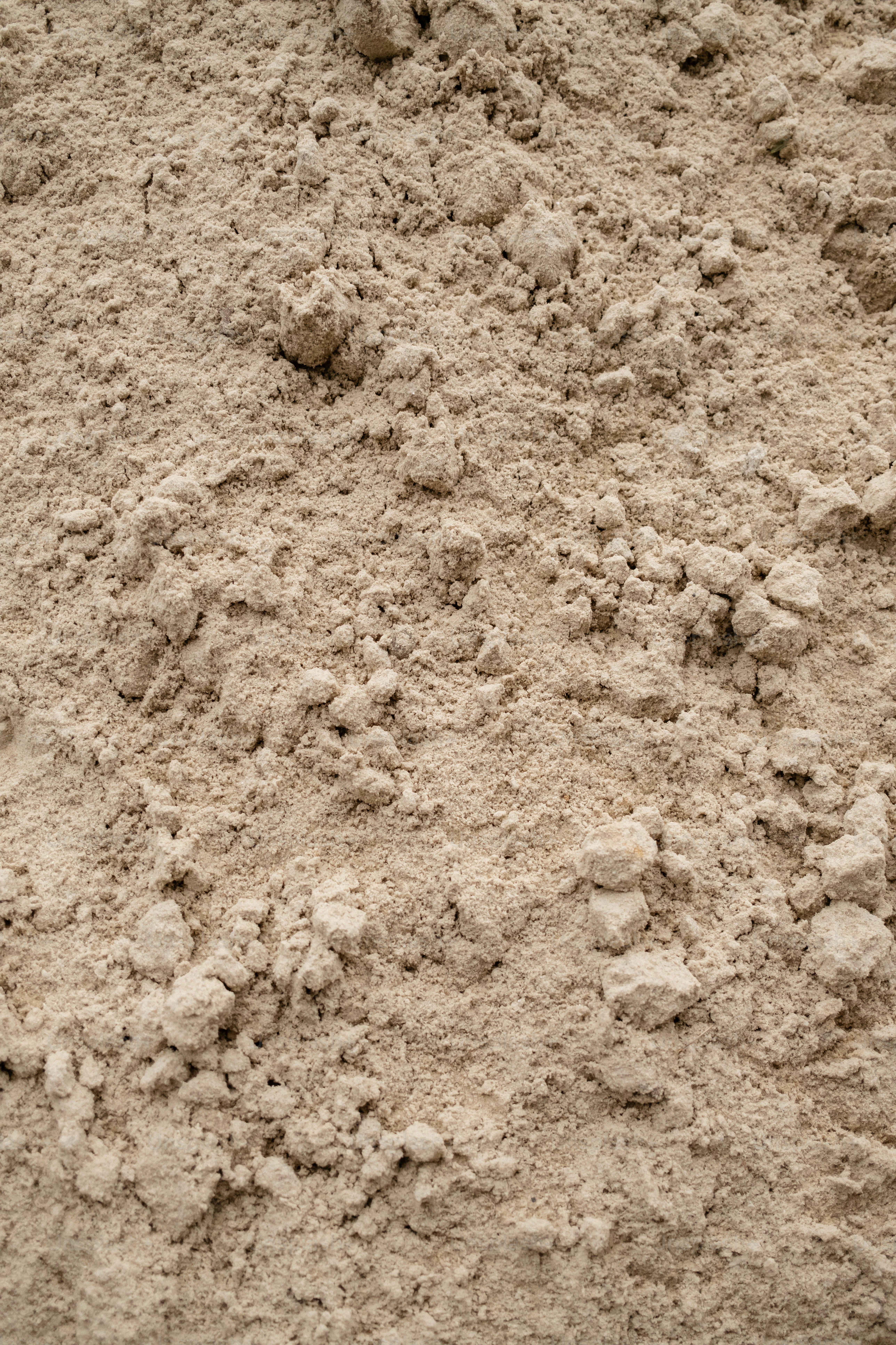 A close up of a dirt surface with small rocks photo – Neutral aesthetic ...