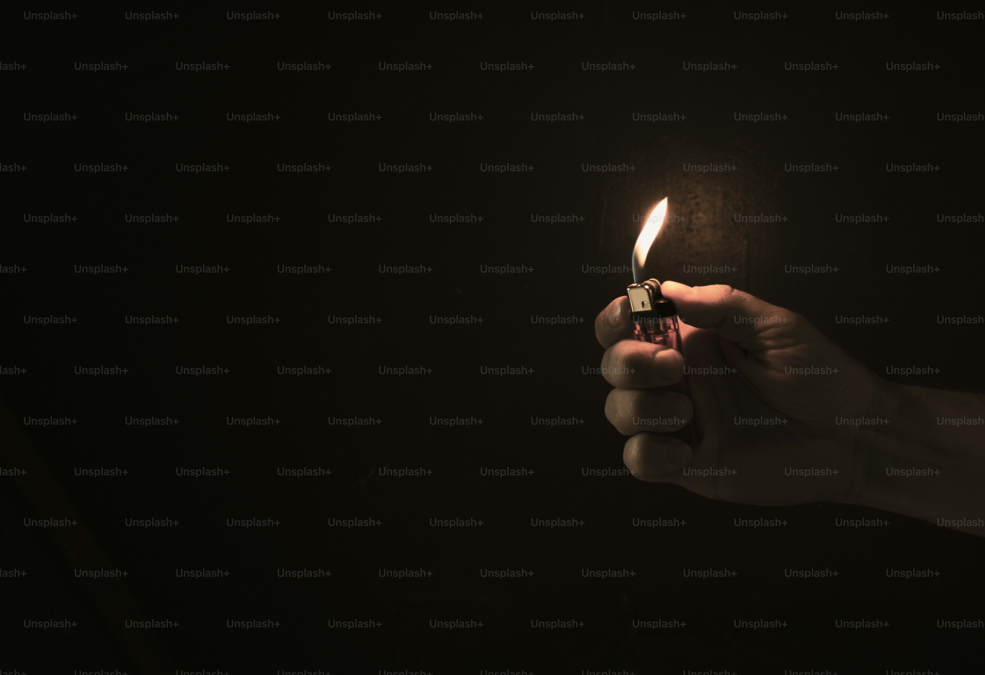 Hand holding lit lighter in the dark photo – Photography Image on Unsplash