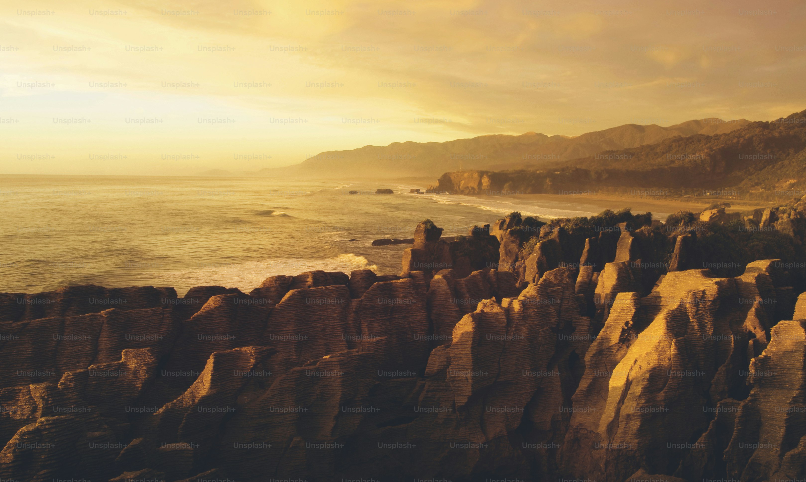 Panaroma of pancake rocks in the scenic view of mountains, beach and ...