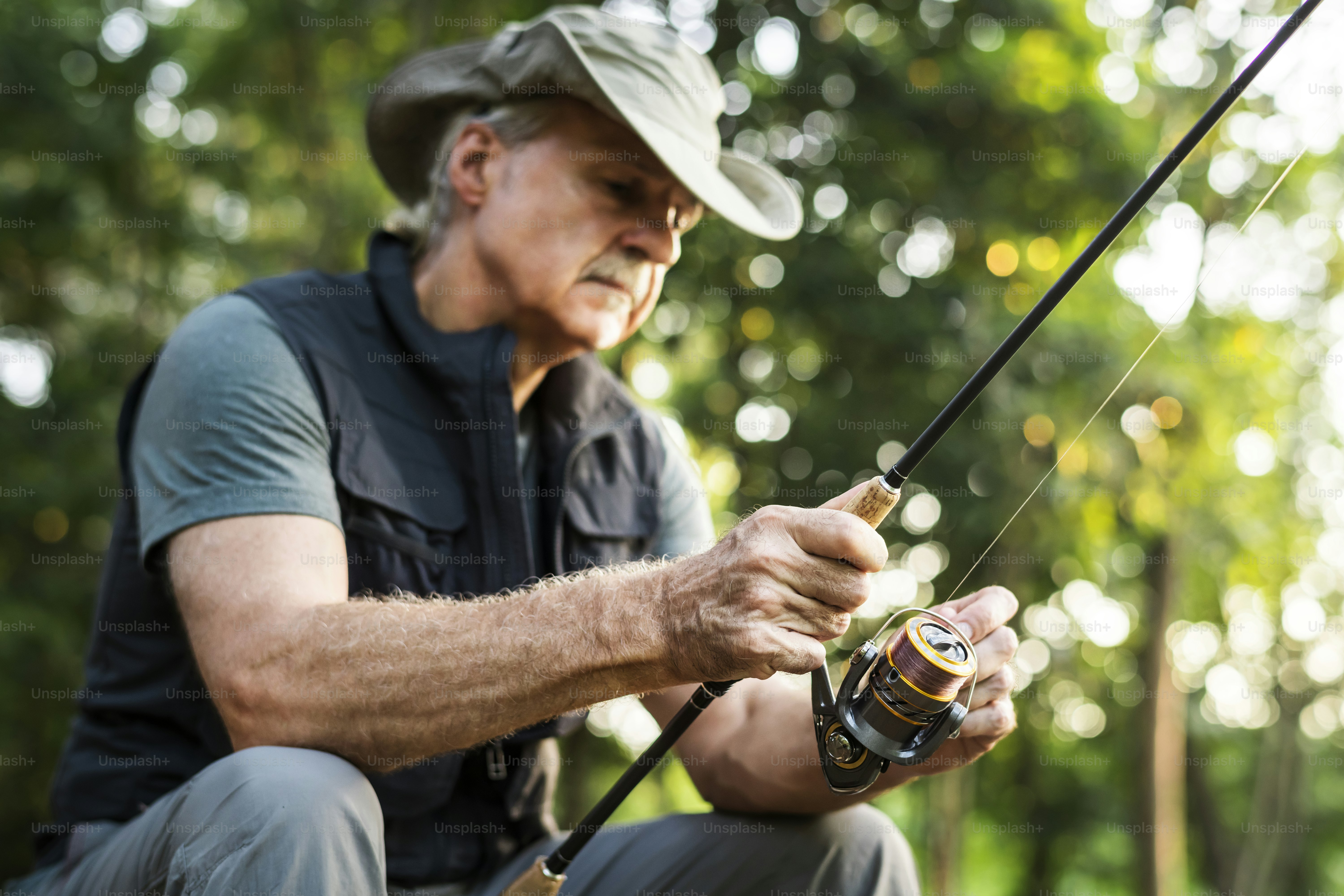 Man fishing by a lake photo – Fisherman Image on Unsplash