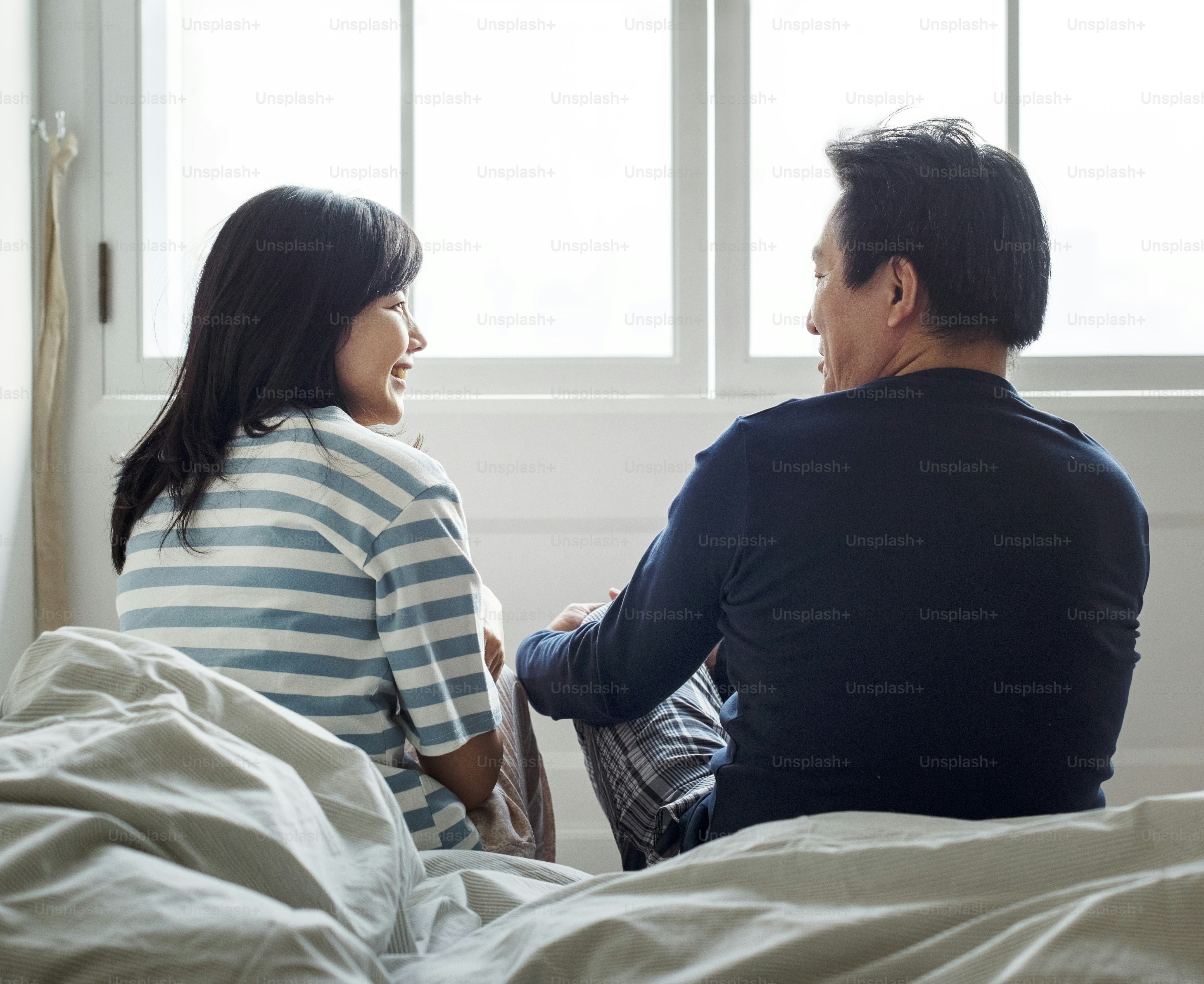 Asian couple talking together in bed photo – Talking Image on Unsplash