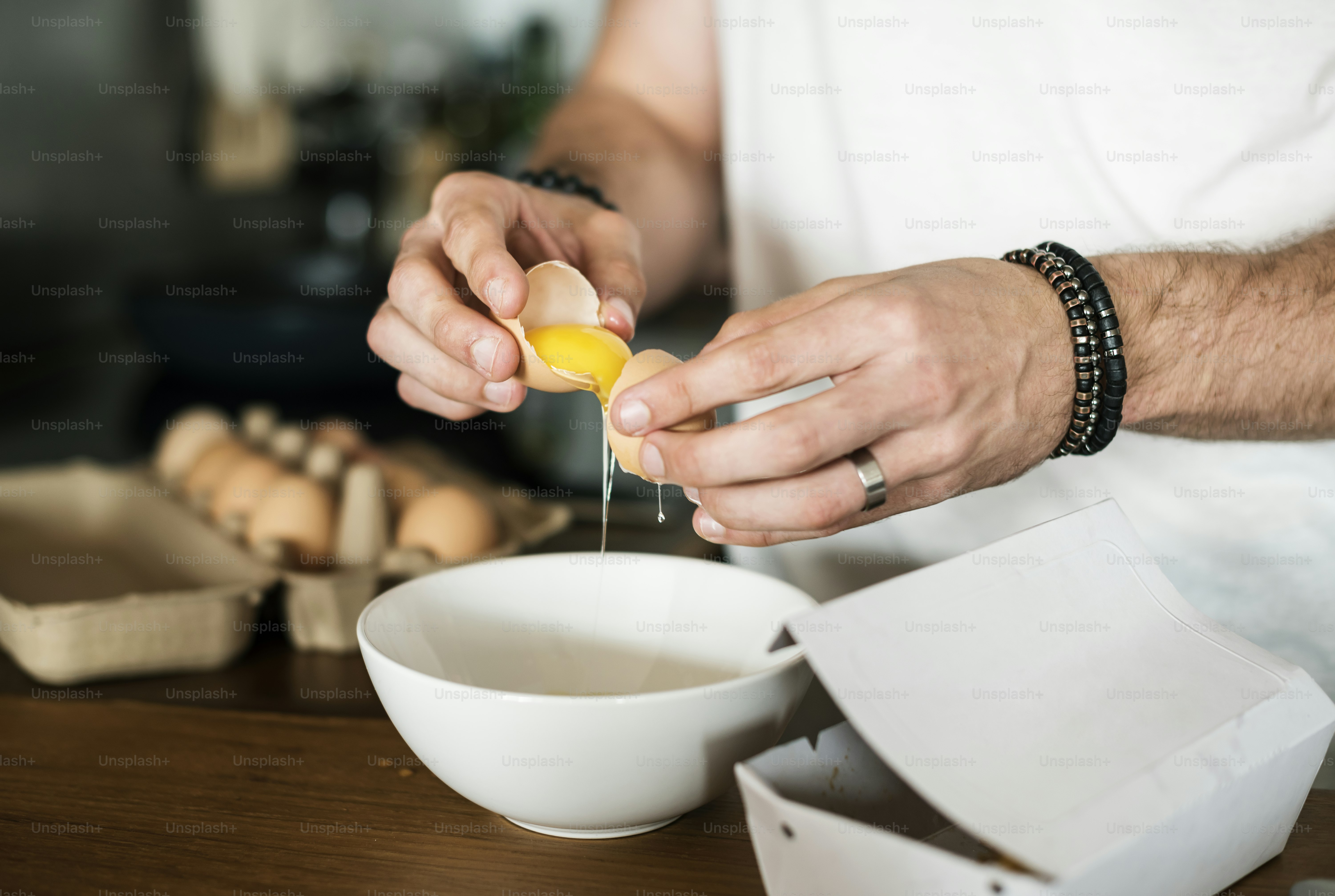 Closeup of man separating egg yolk photo – Food and drink Image on Unsplash