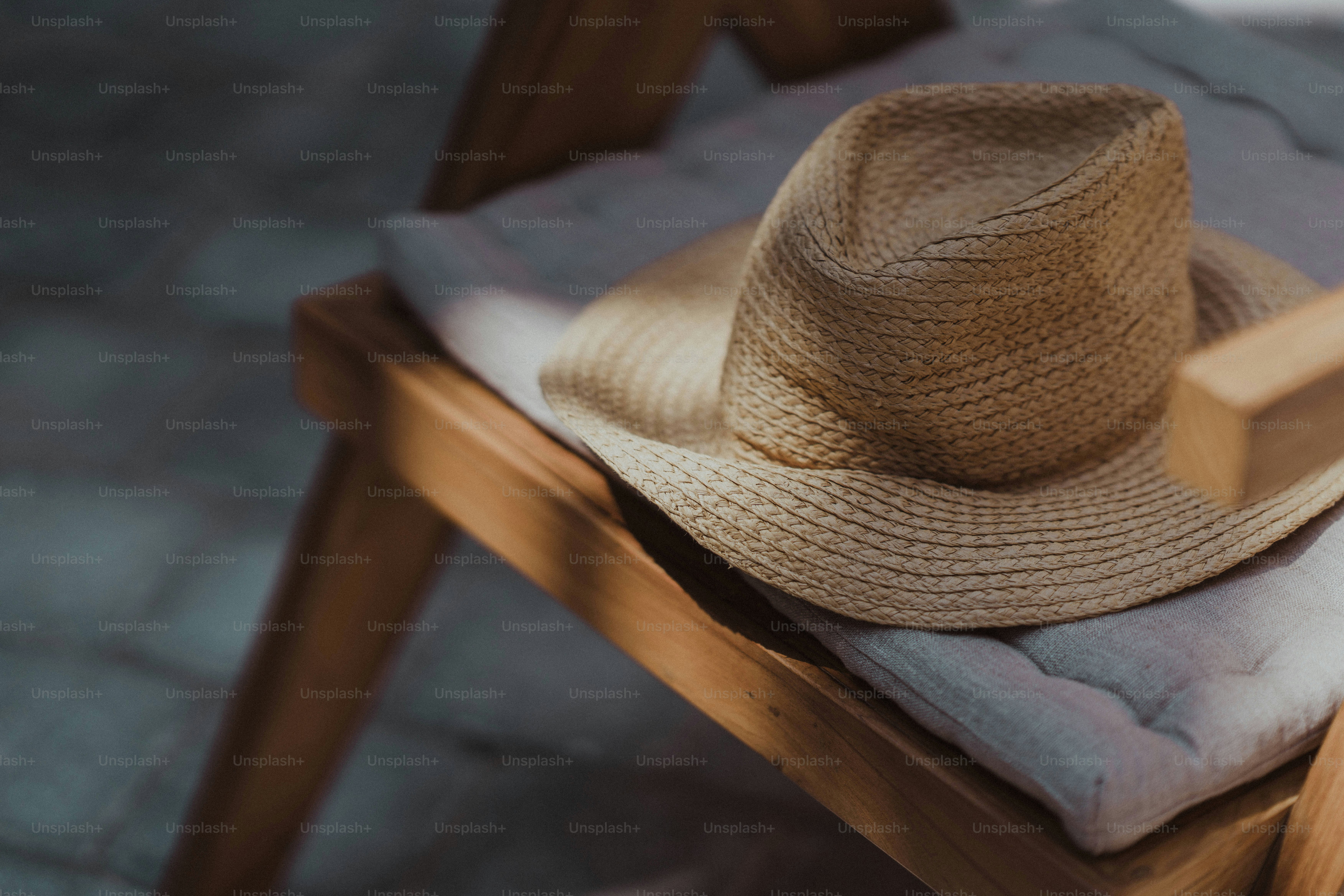 A hat sitting on top of a wooden chair photo – Wood Image on Unsplash