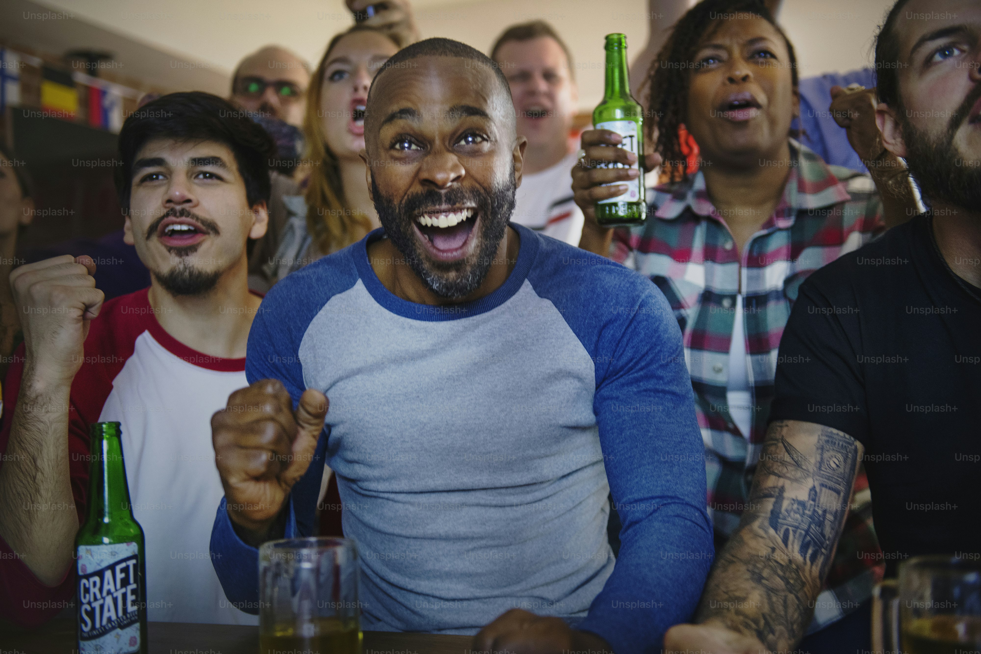 Friends cheering sport at bar together photo – Celebration Image on ...