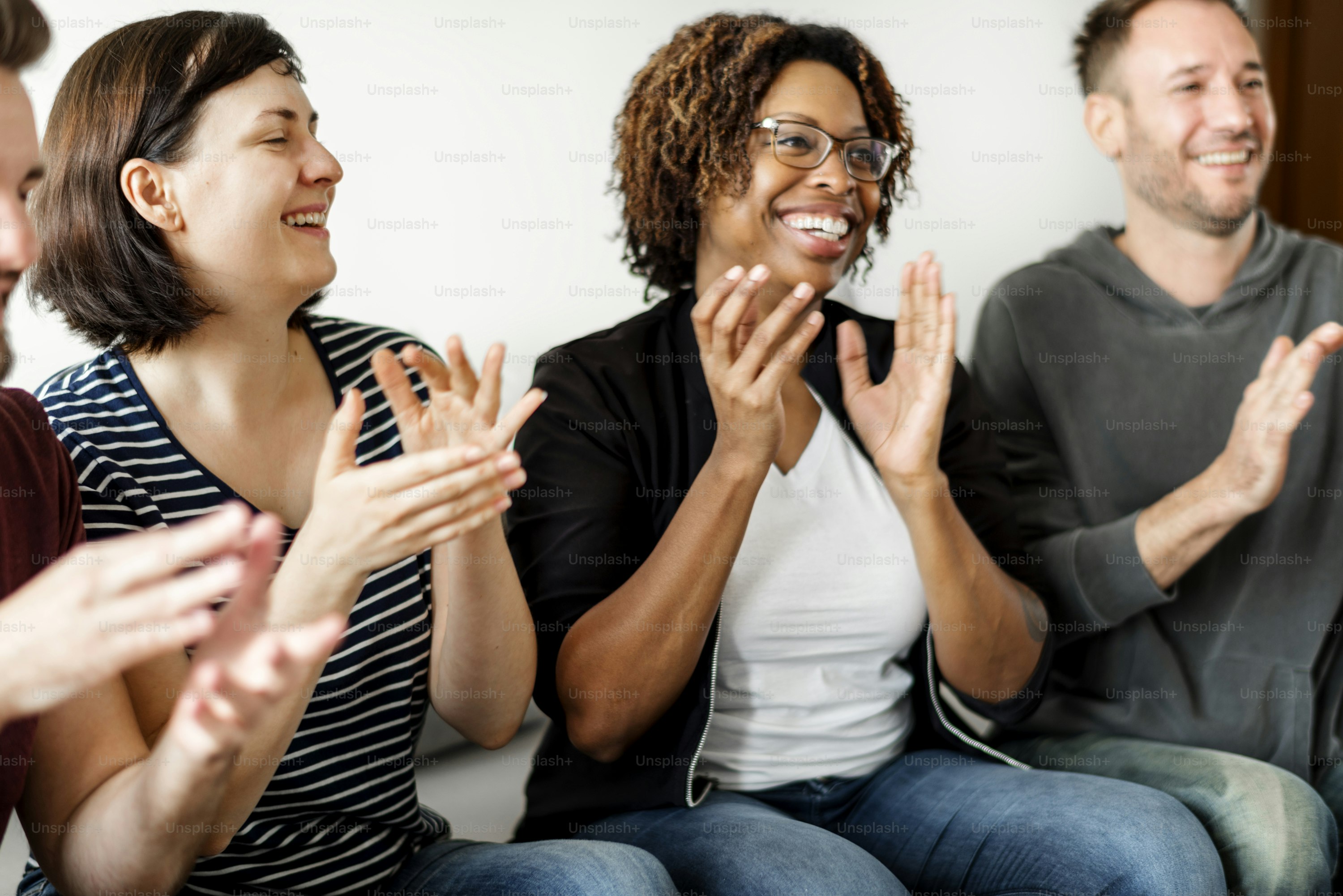 People clapping together sitting on a sofa photo – Adults only Image on ...