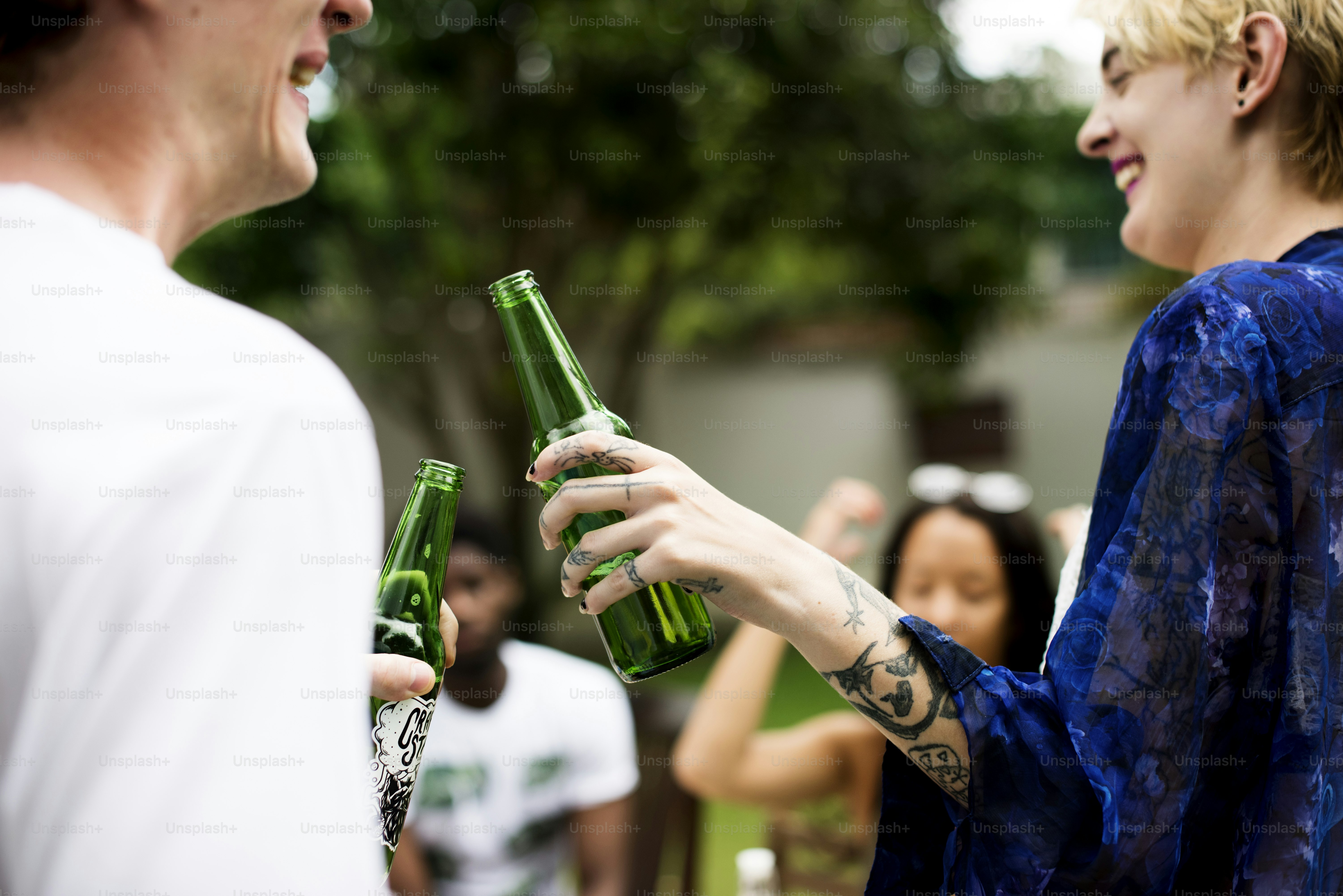 Group of diverse friends celebrating drinking beers together summer ...