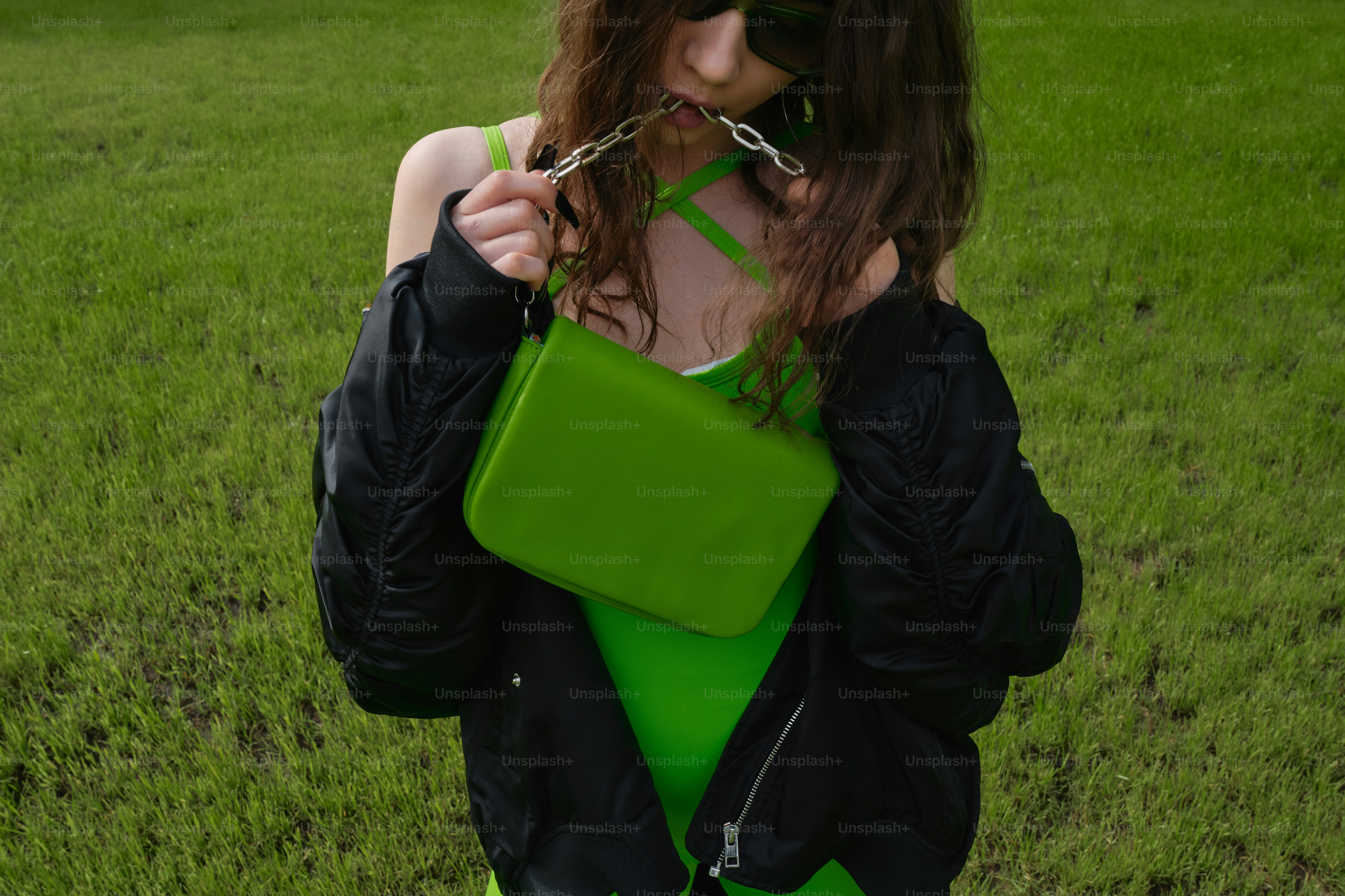 A woman in a green dress holding a green purse photo – Generation z ...