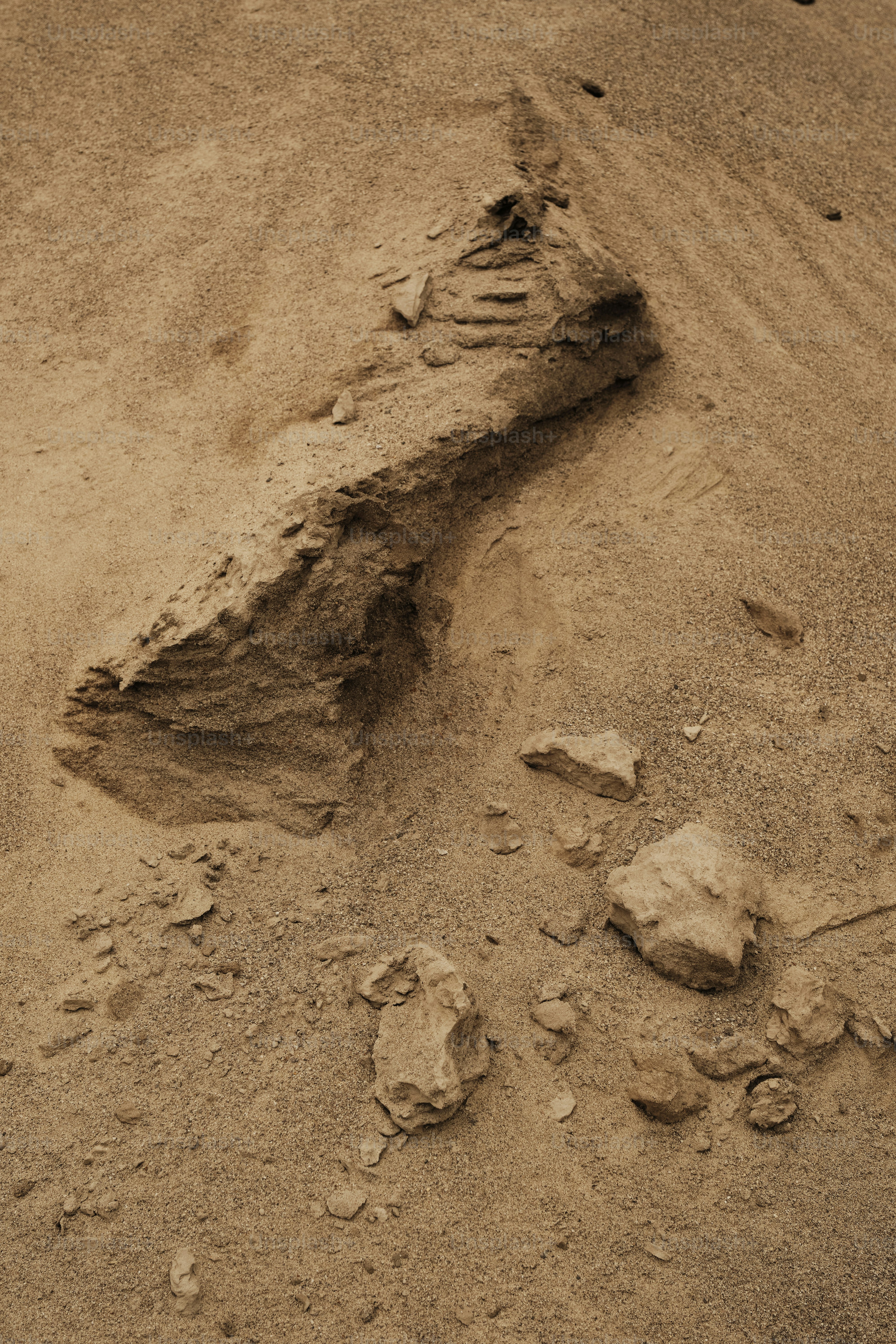 A large rock in the middle of a dirt field photo – Neutral background ...