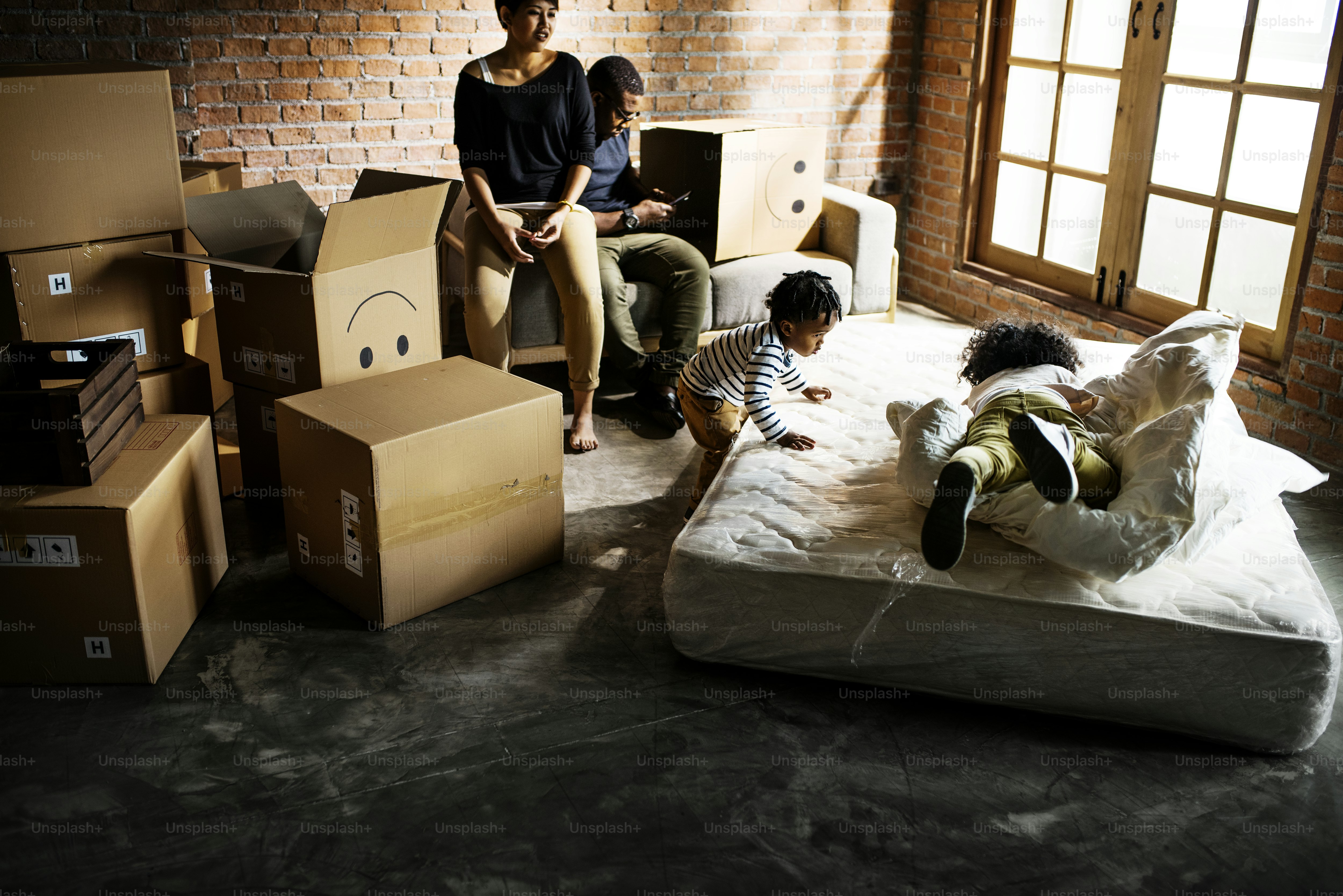 African family unpacking things after moving to a new place photo ...