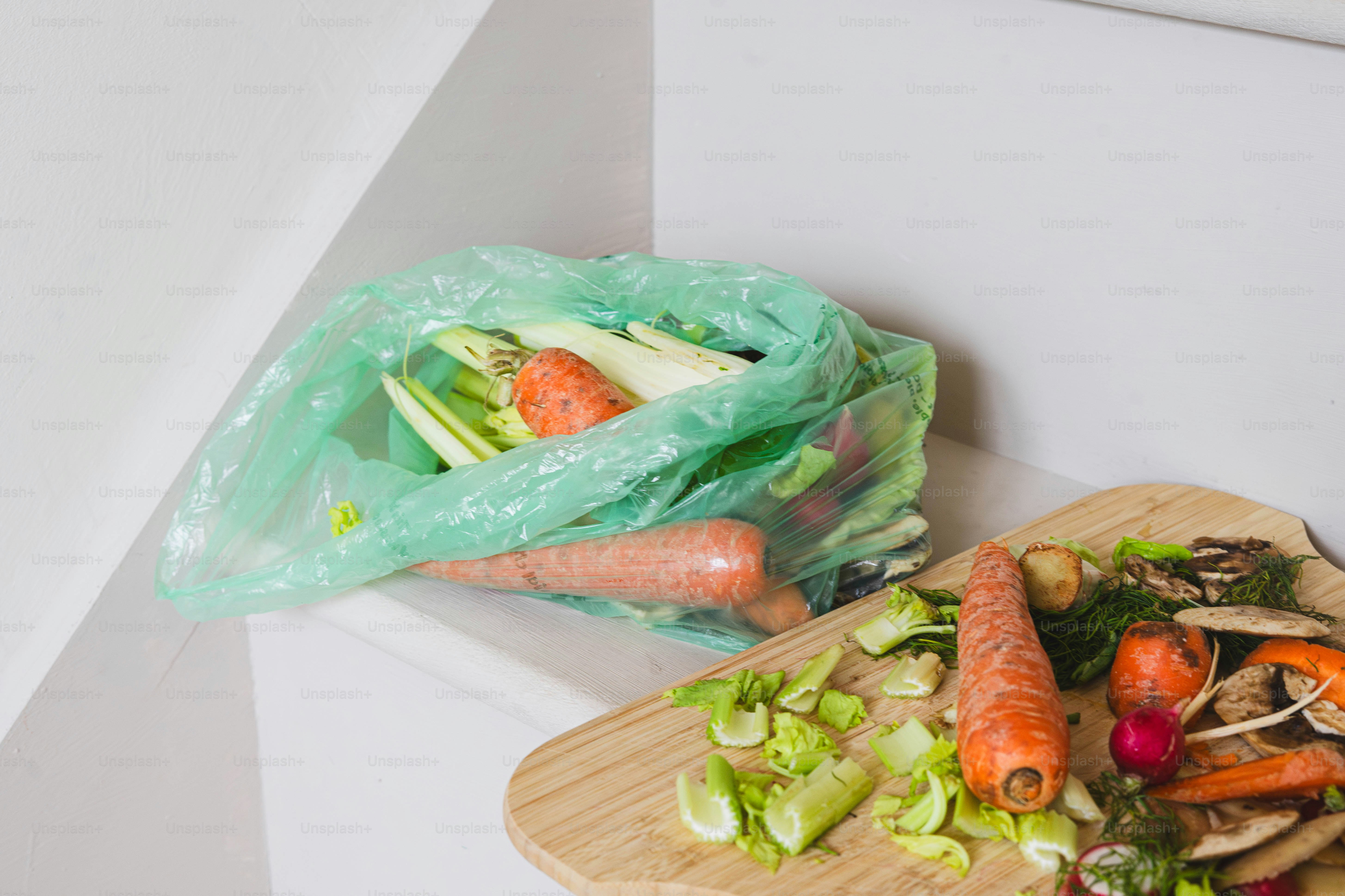 A pile of vegetables sitting on top of a wooden cutting board photo ...