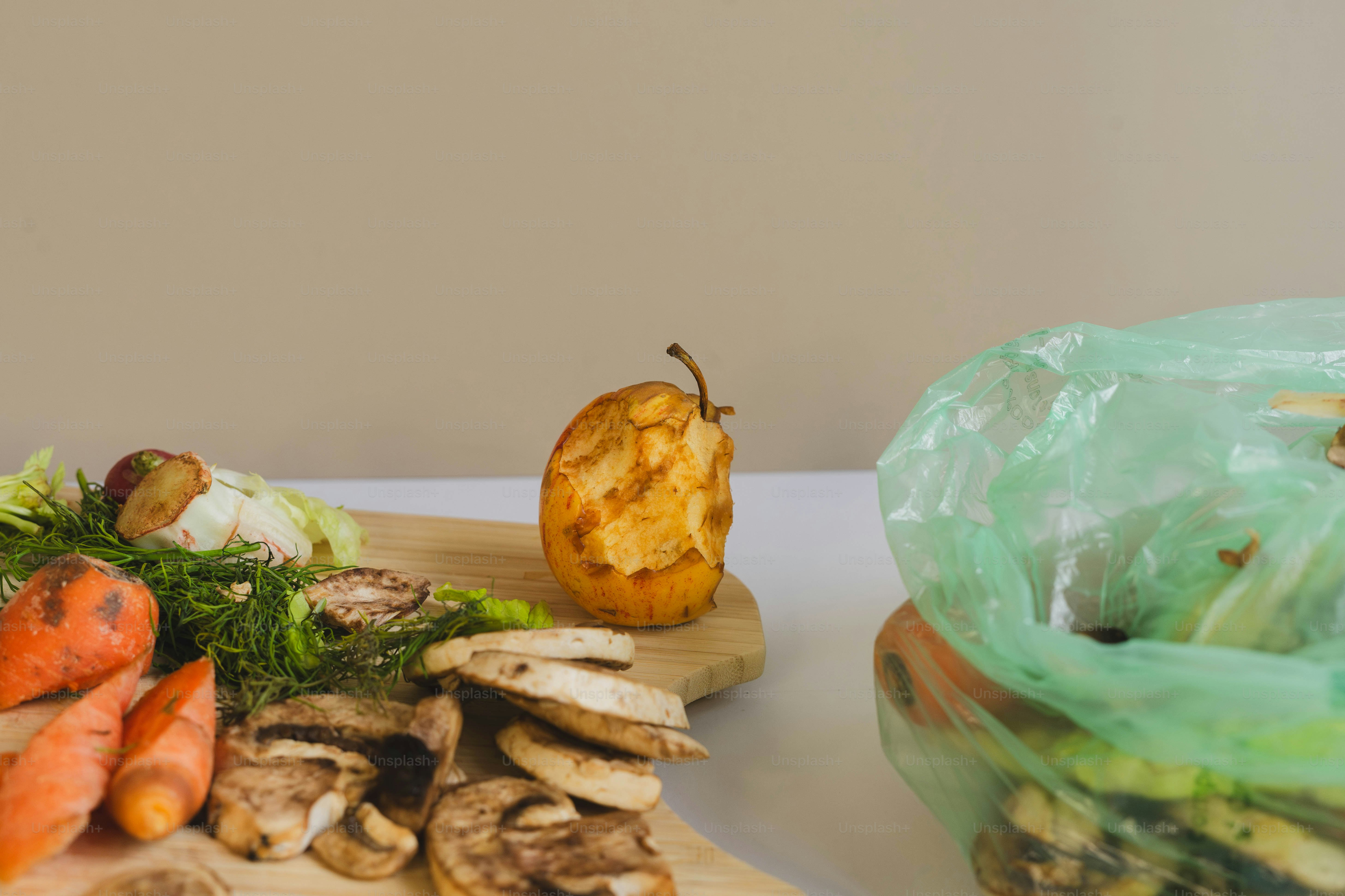 A pile of vegetables sitting on top of a wooden cutting board photo ...