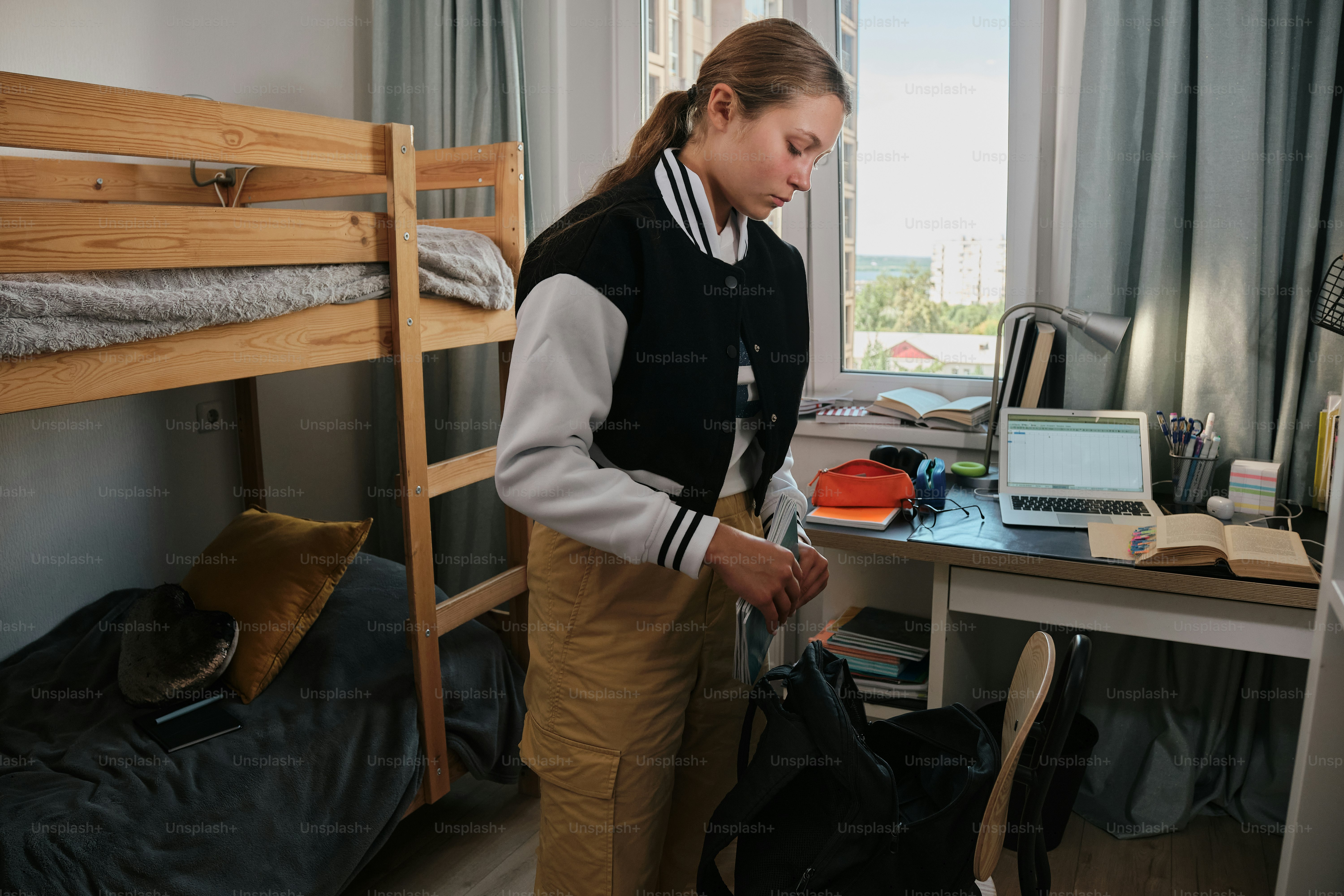 A woman standing in front of a laptop computer photo – Student Image on ...