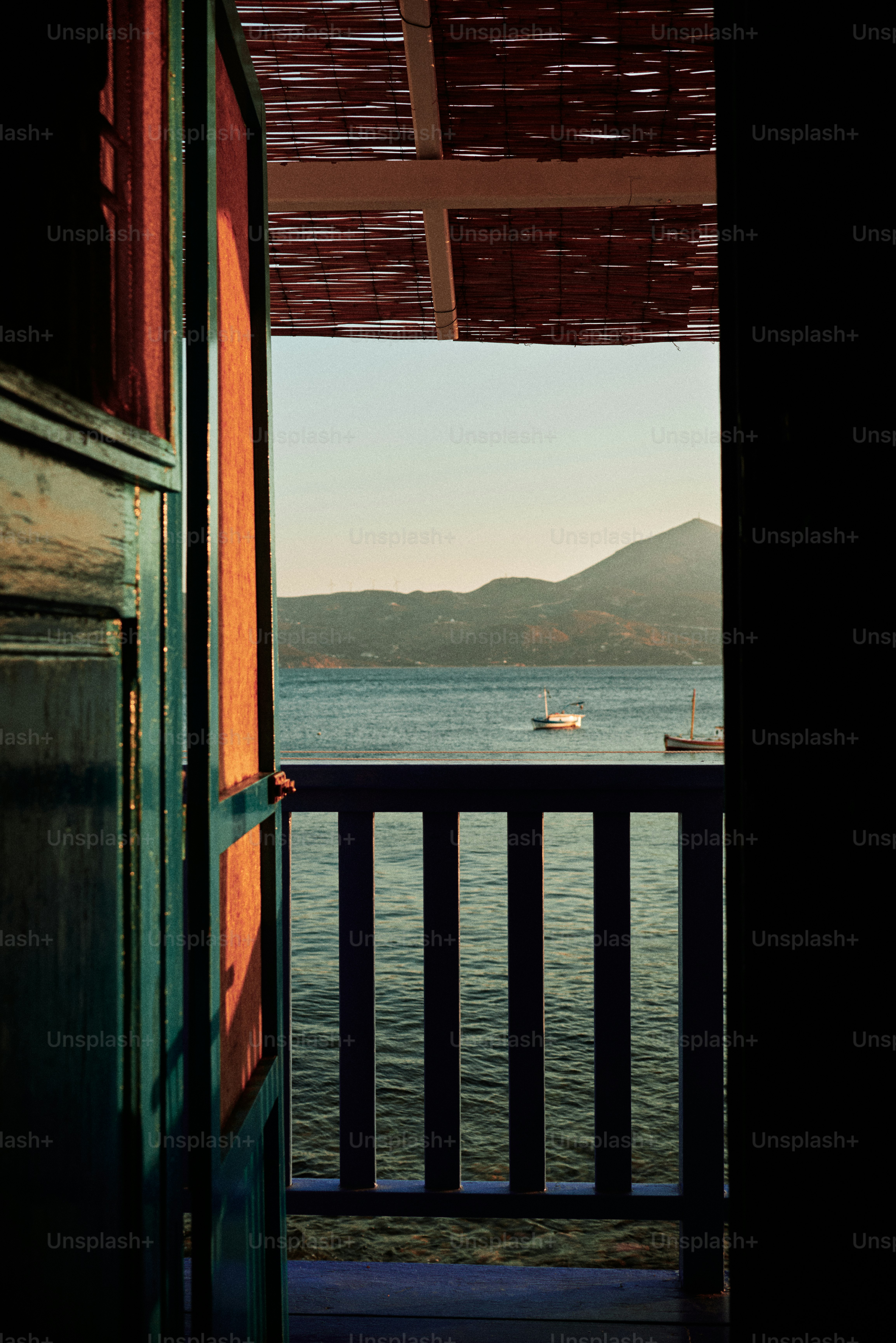 A view of a body of water from a porch photo – Summer Image on Unsplash