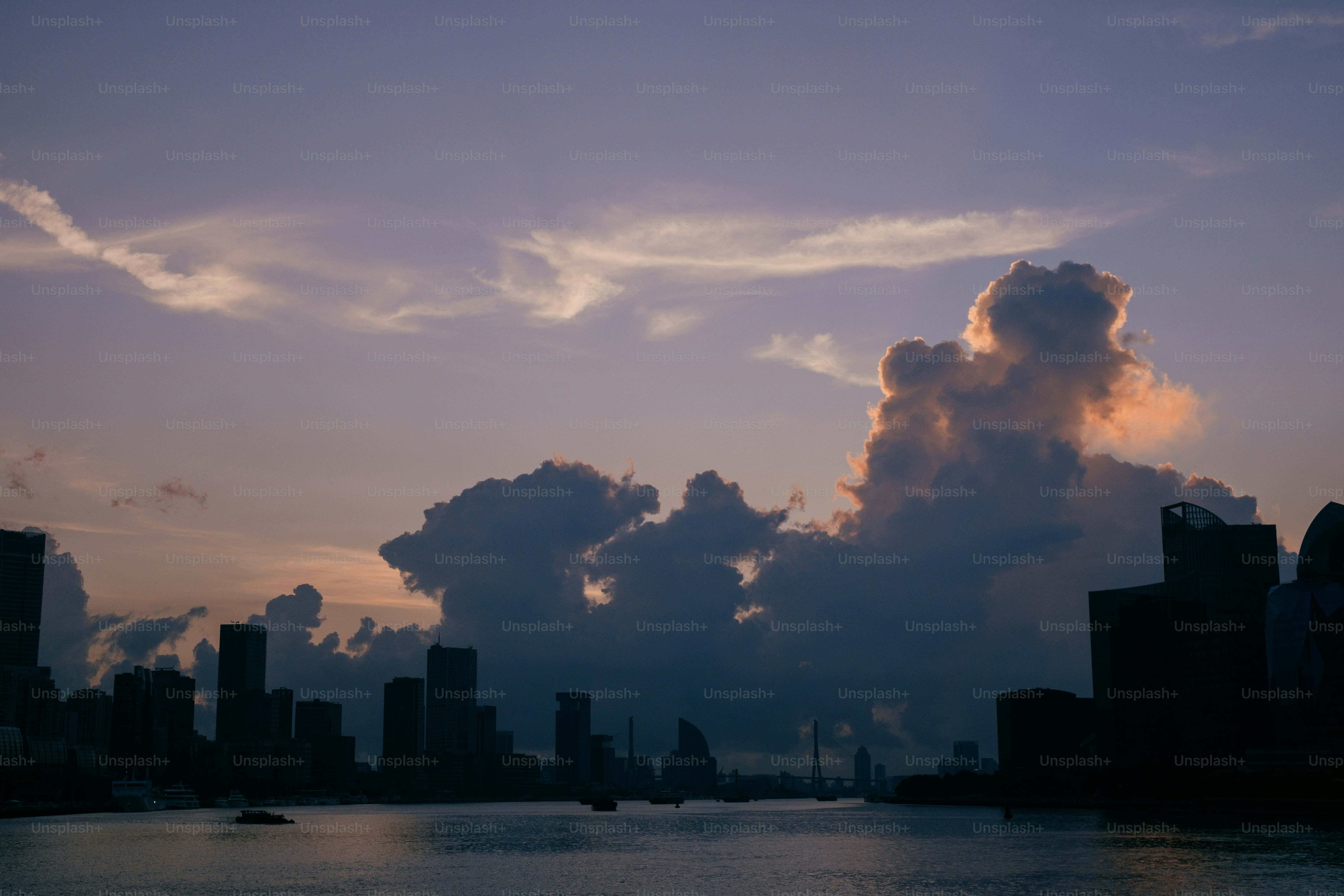 A view of a city at night from the water photo – Cityscape Image on ...