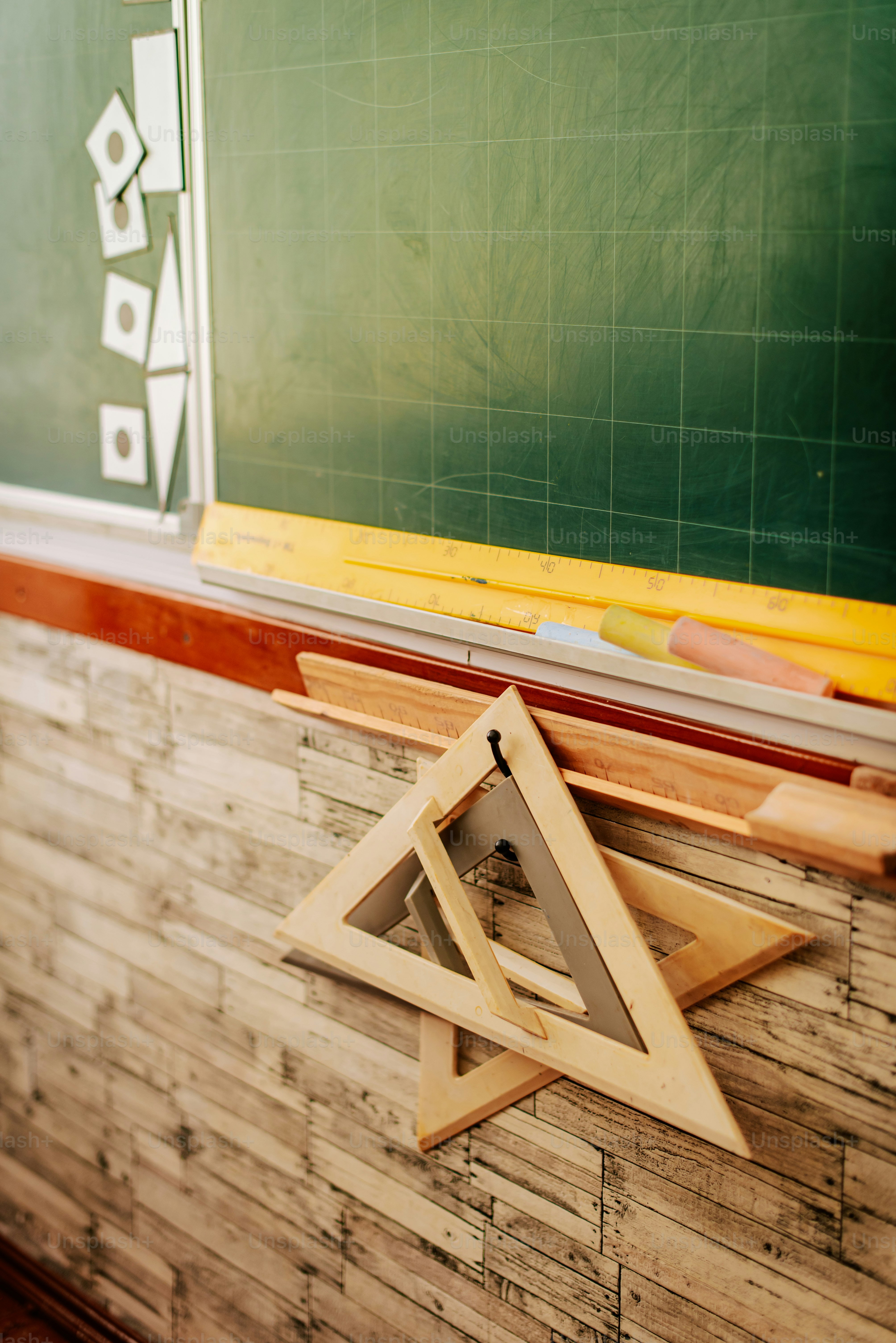 A blackboard with a wooden triangle on it photo – Maths set Image on ...
