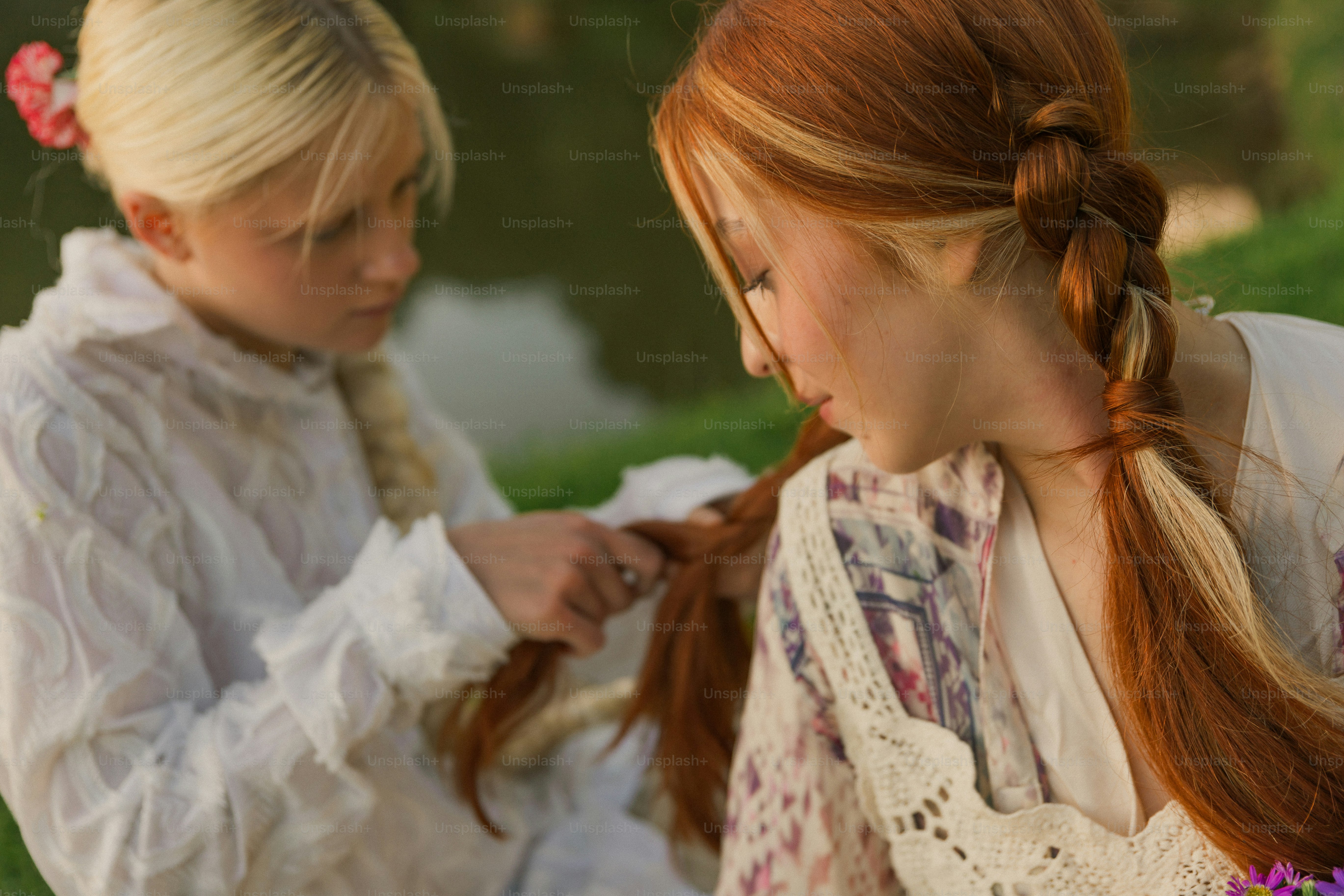 Two young girls dressed in historical clothing, one of which is ...