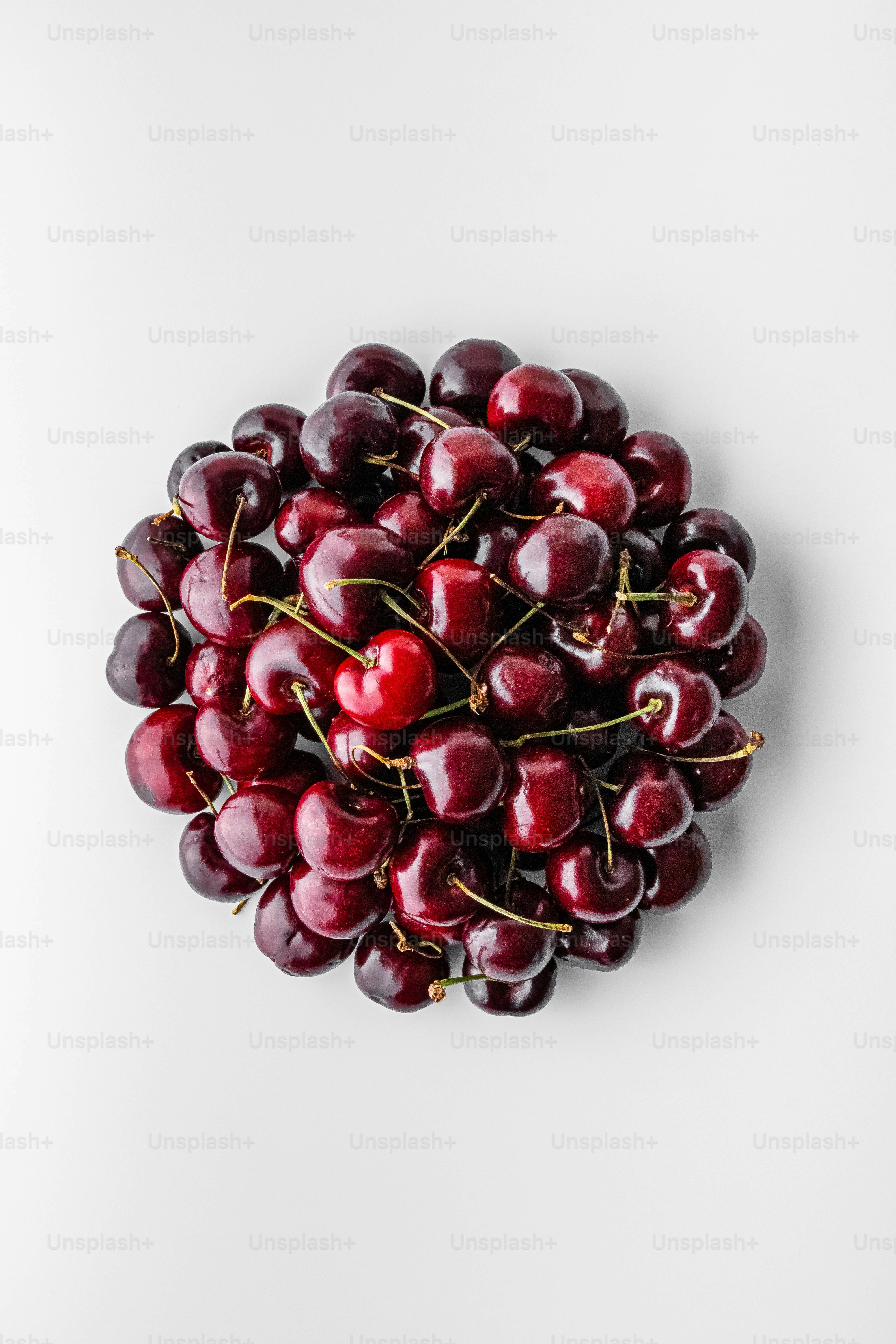 A bunch of cherries sitting on top of a white surface photo – Cherries ...