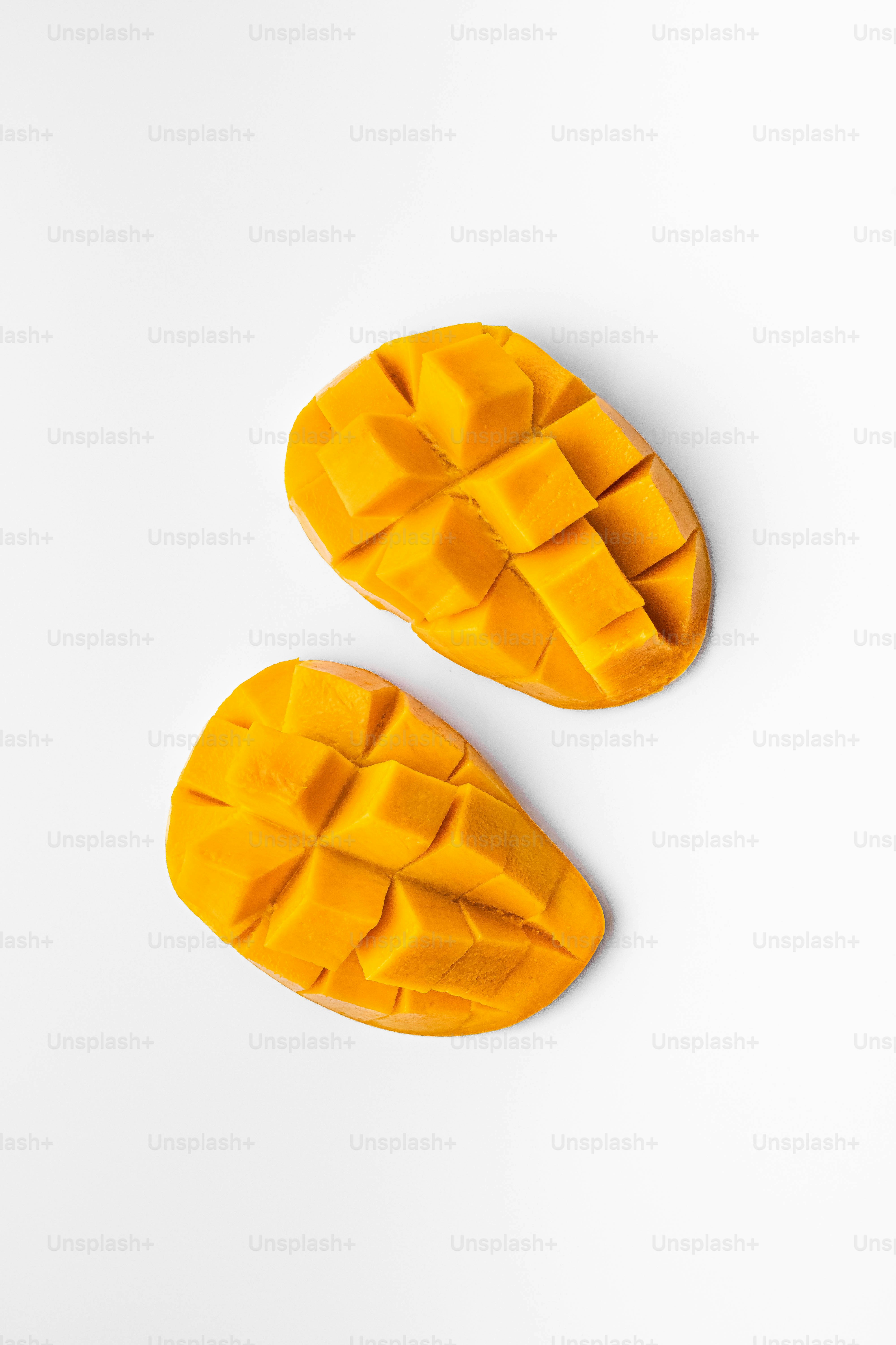 A mango and a piece of mango on a white background photo – Mango Image ...