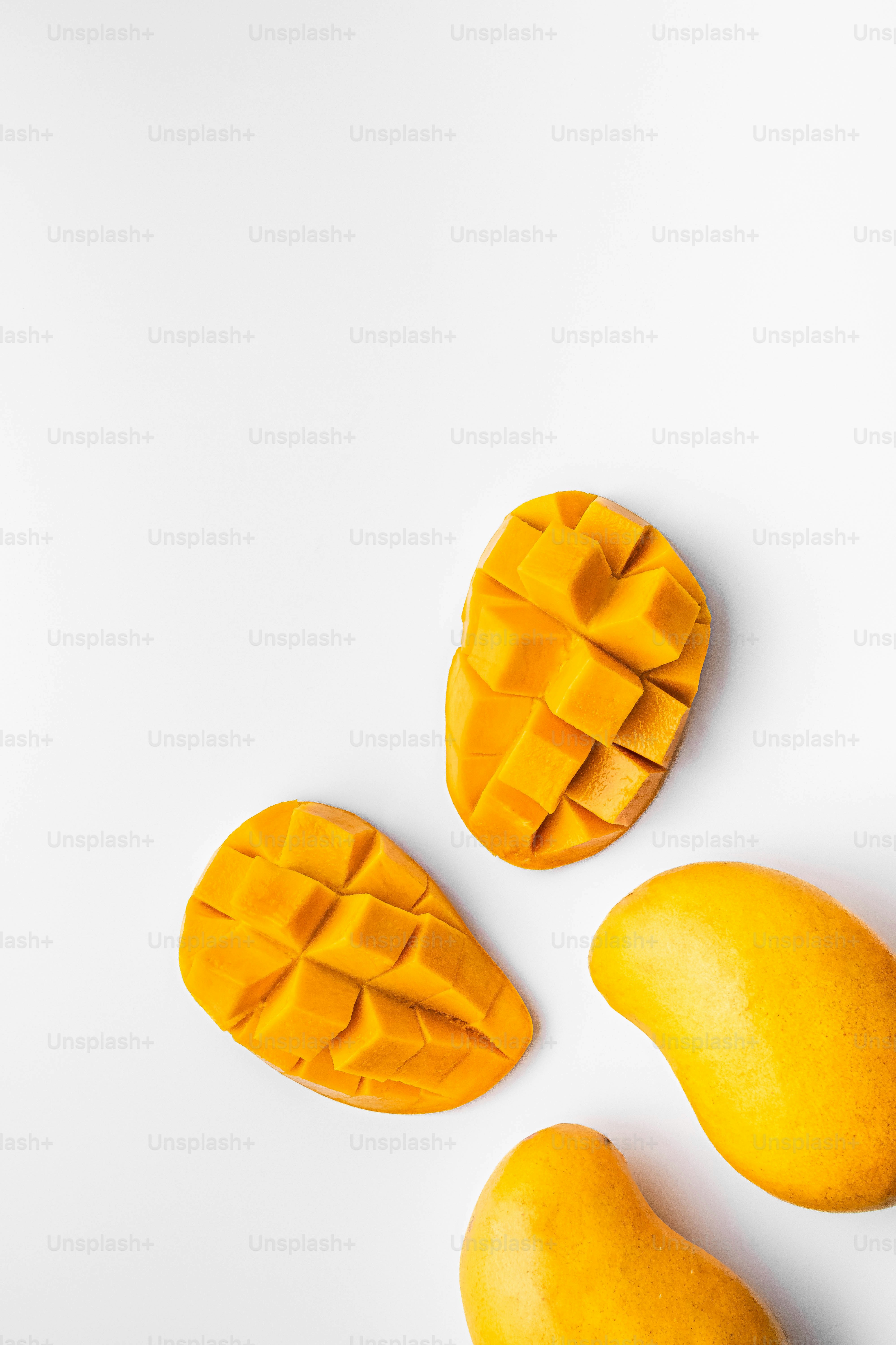 A mango and a piece of mango on a white background photo – Mango Image ...