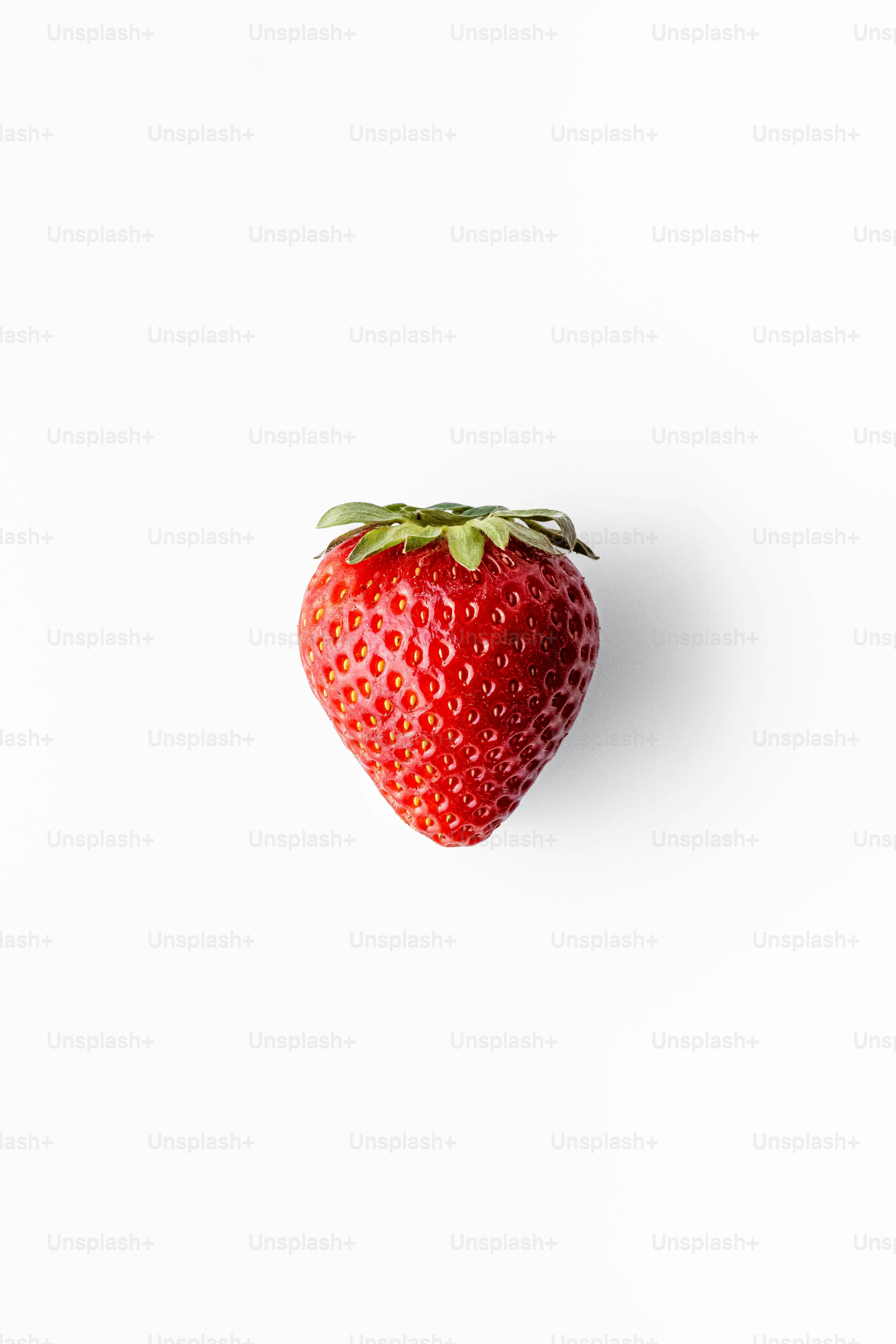 A single strawberry on a white background photo – Strawberries Image on ...