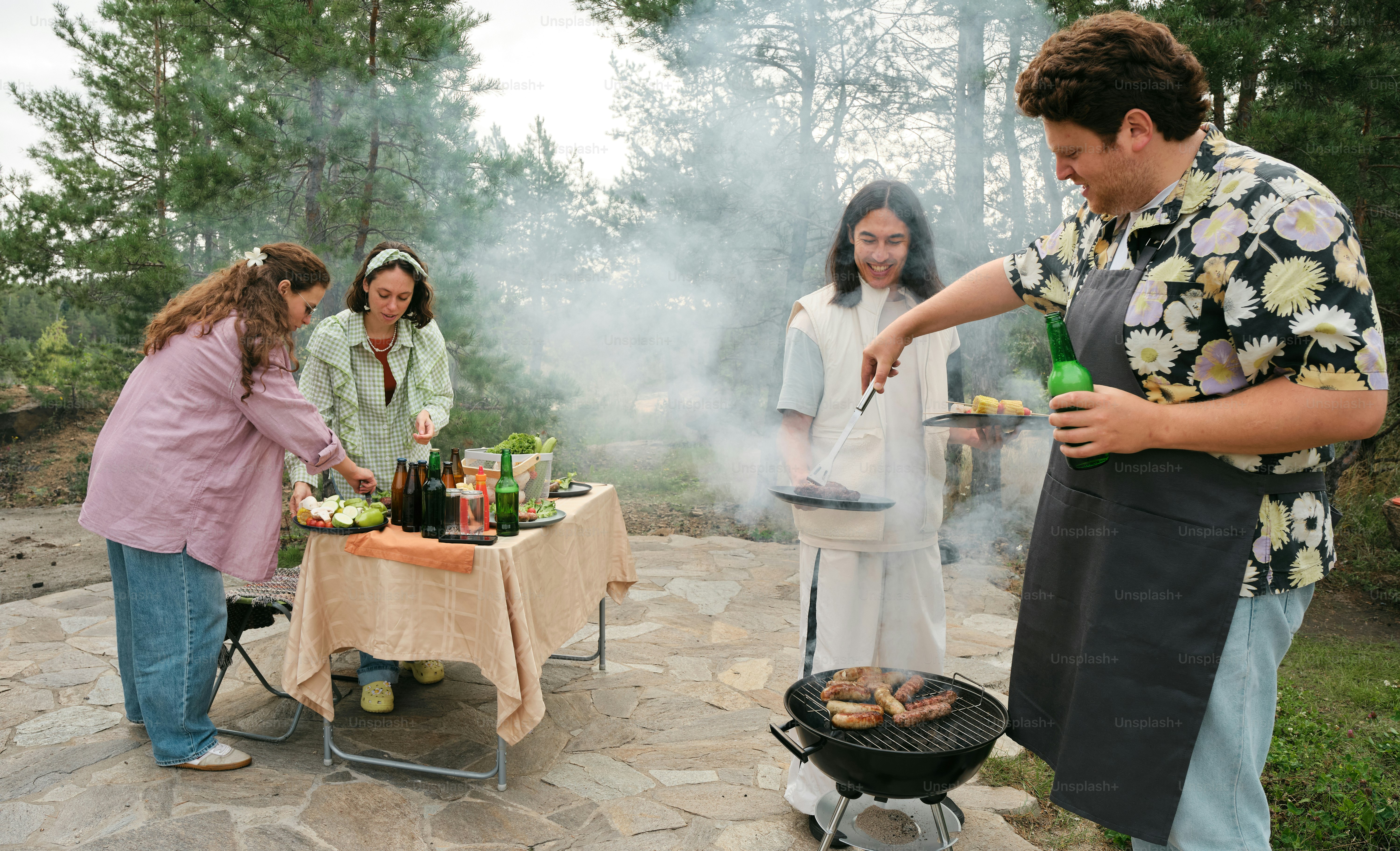 A group of people standing around a bbq grill photo – Grill Image on ...