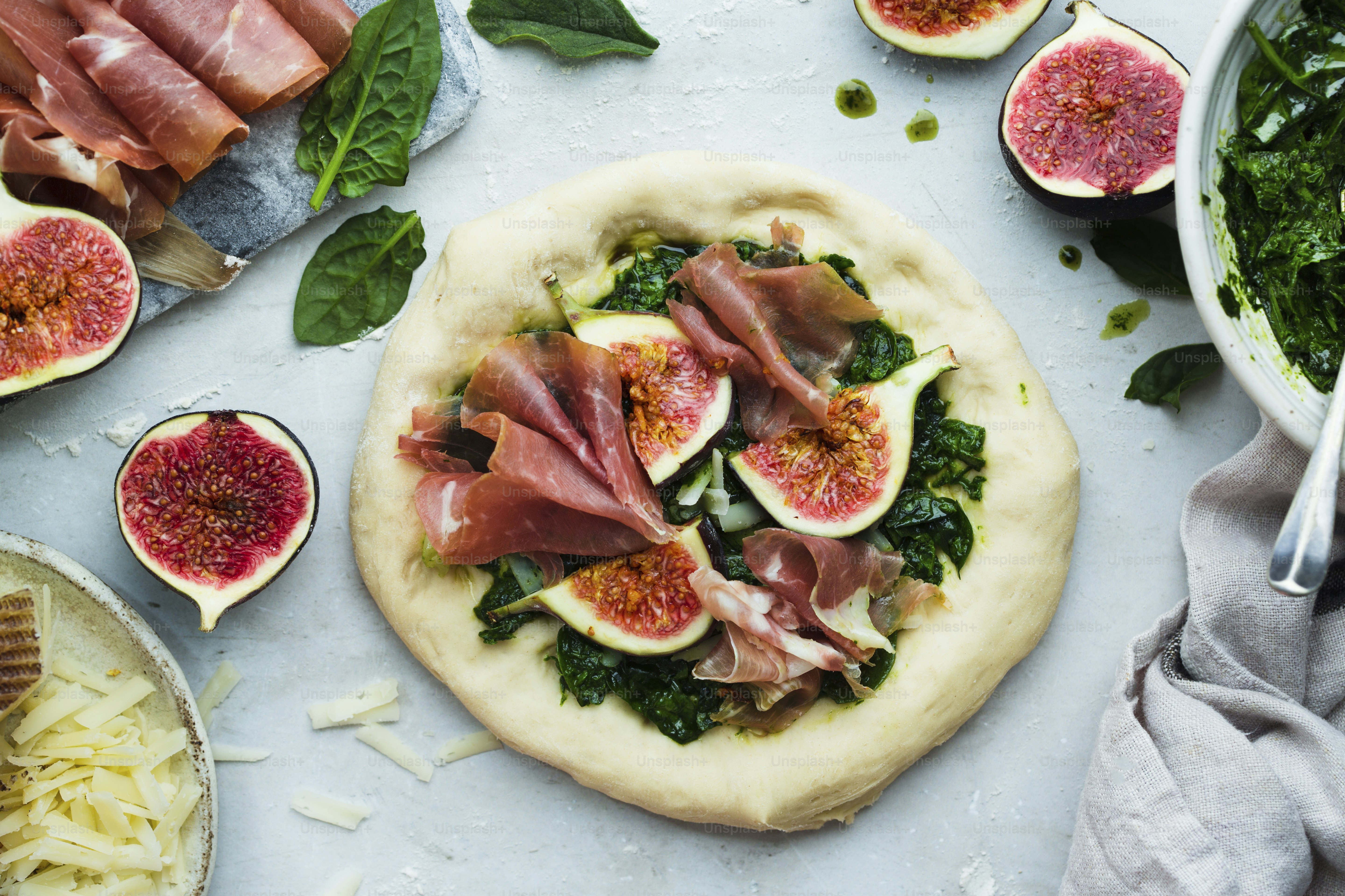 A table topped with a pizza covered in toppings photo – Cooking with ...