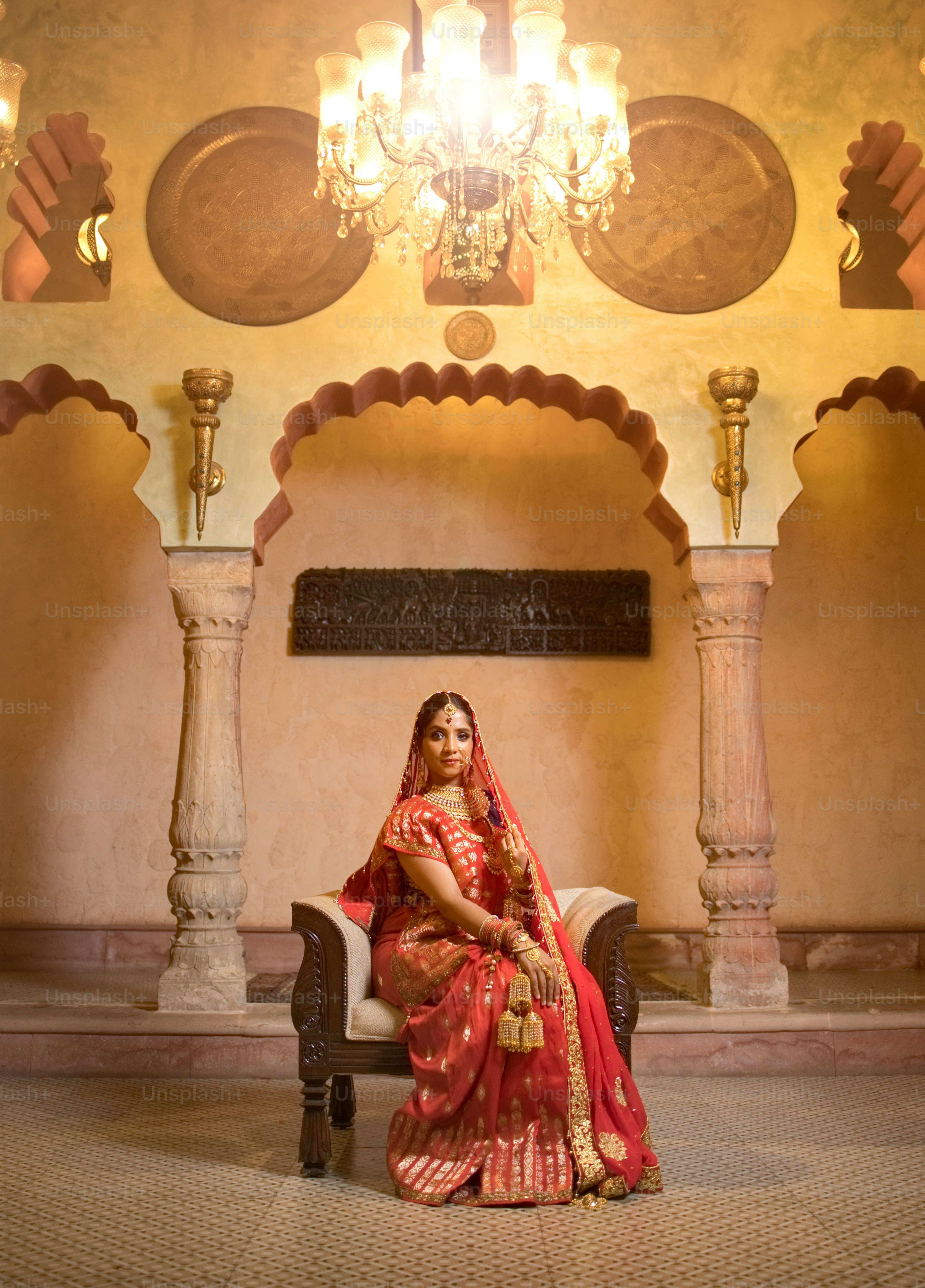 A woman sitting on a chair in a room photo – Indian bride Image on Unsplash