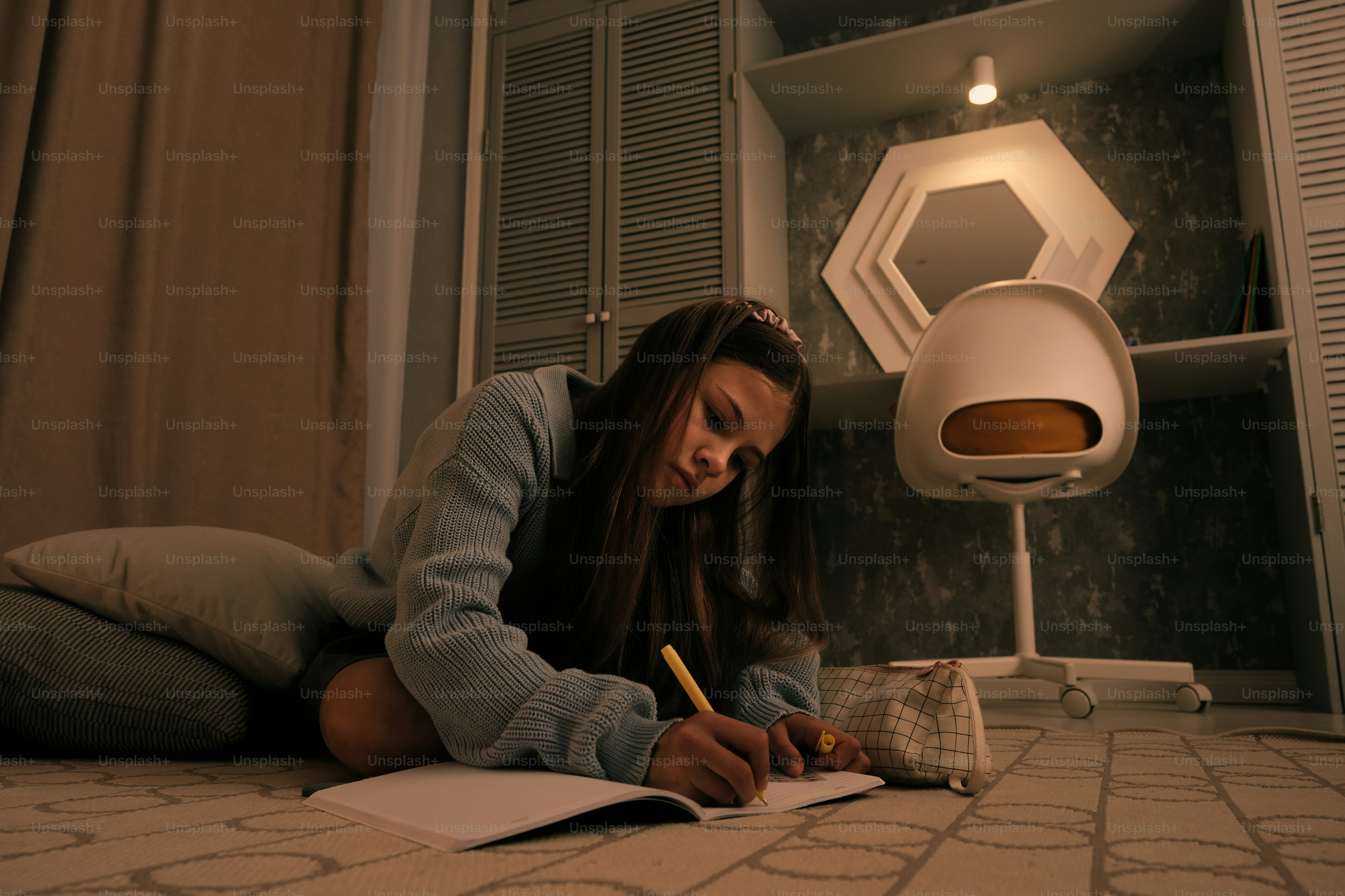 A woman laying on the floor writing on a piece of paper photo – Girl ...