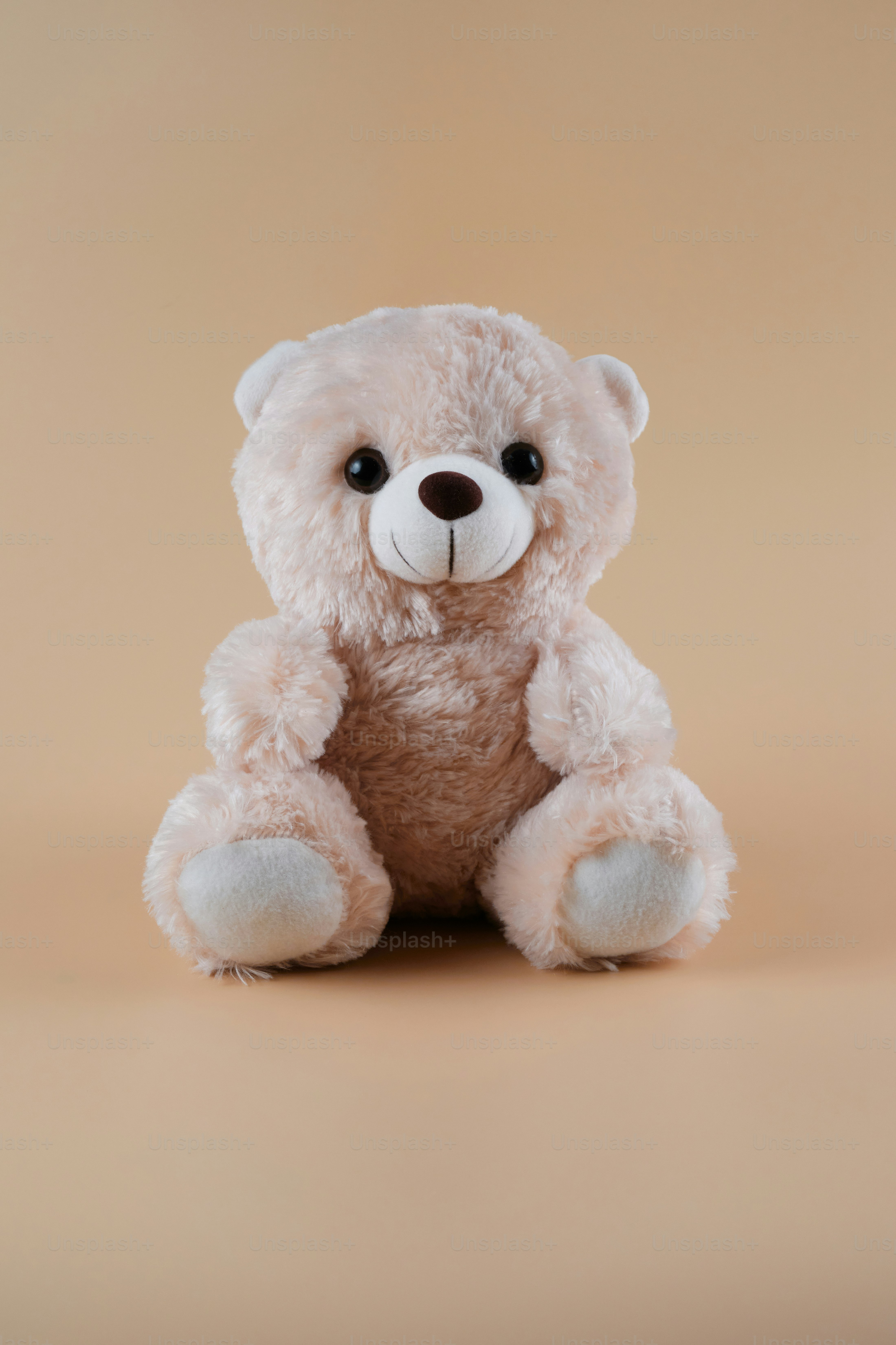 A small teddy bear sitting on a brown background photo – Teddy bear ...