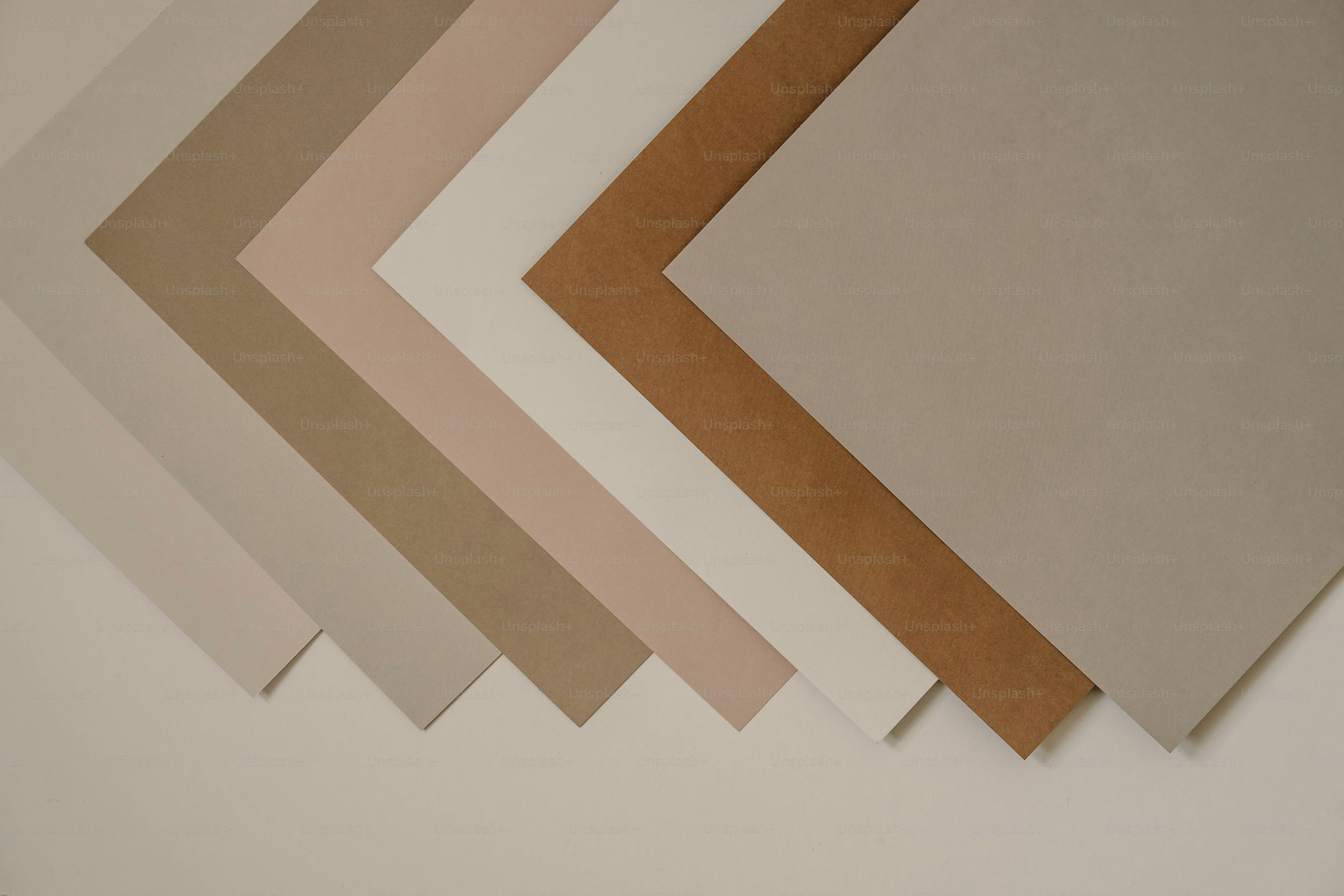 A group of different colors of paper on a wall photo – Paper texture ...