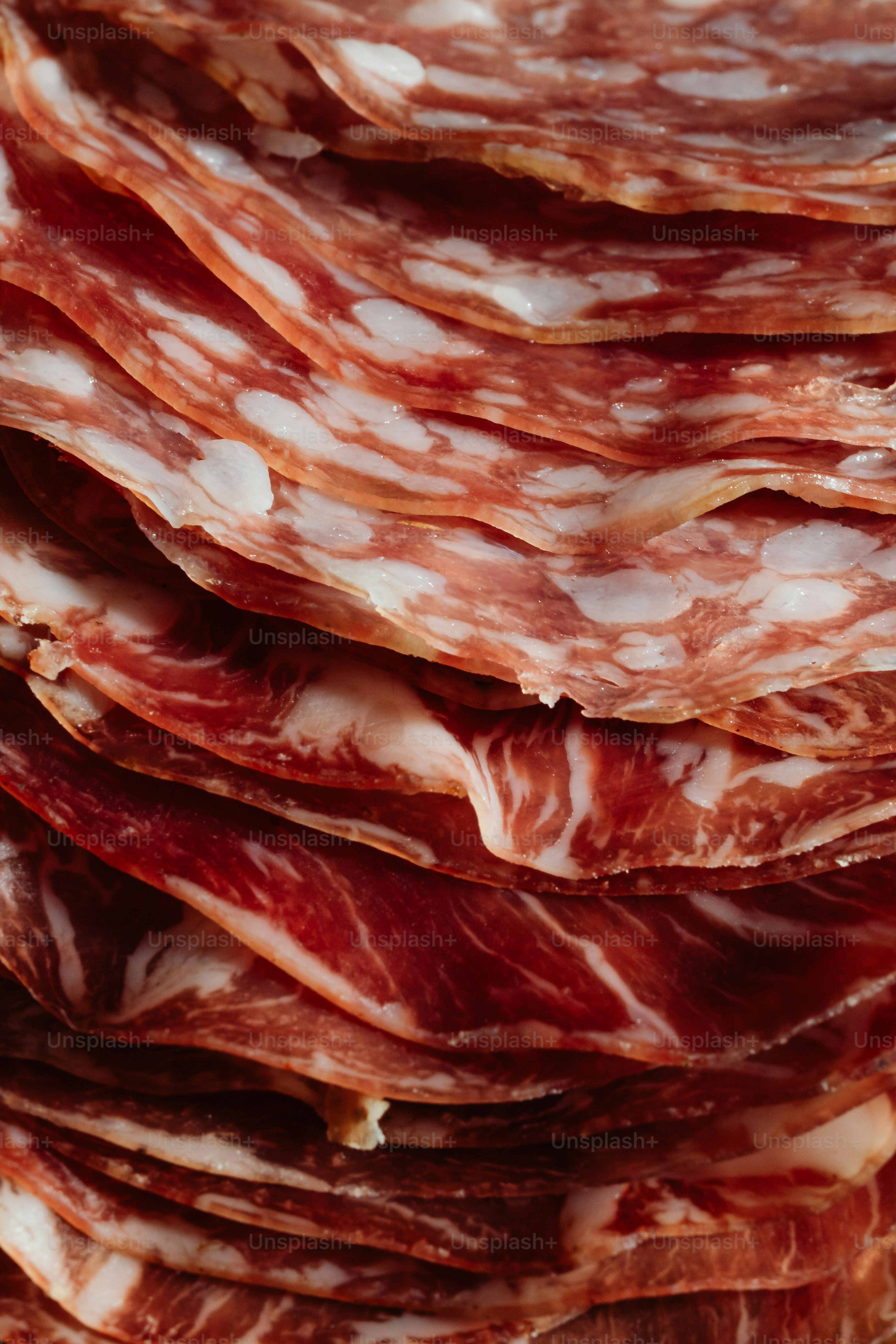 A pile of raw meat sitting on top of a table photo – Close up food ...