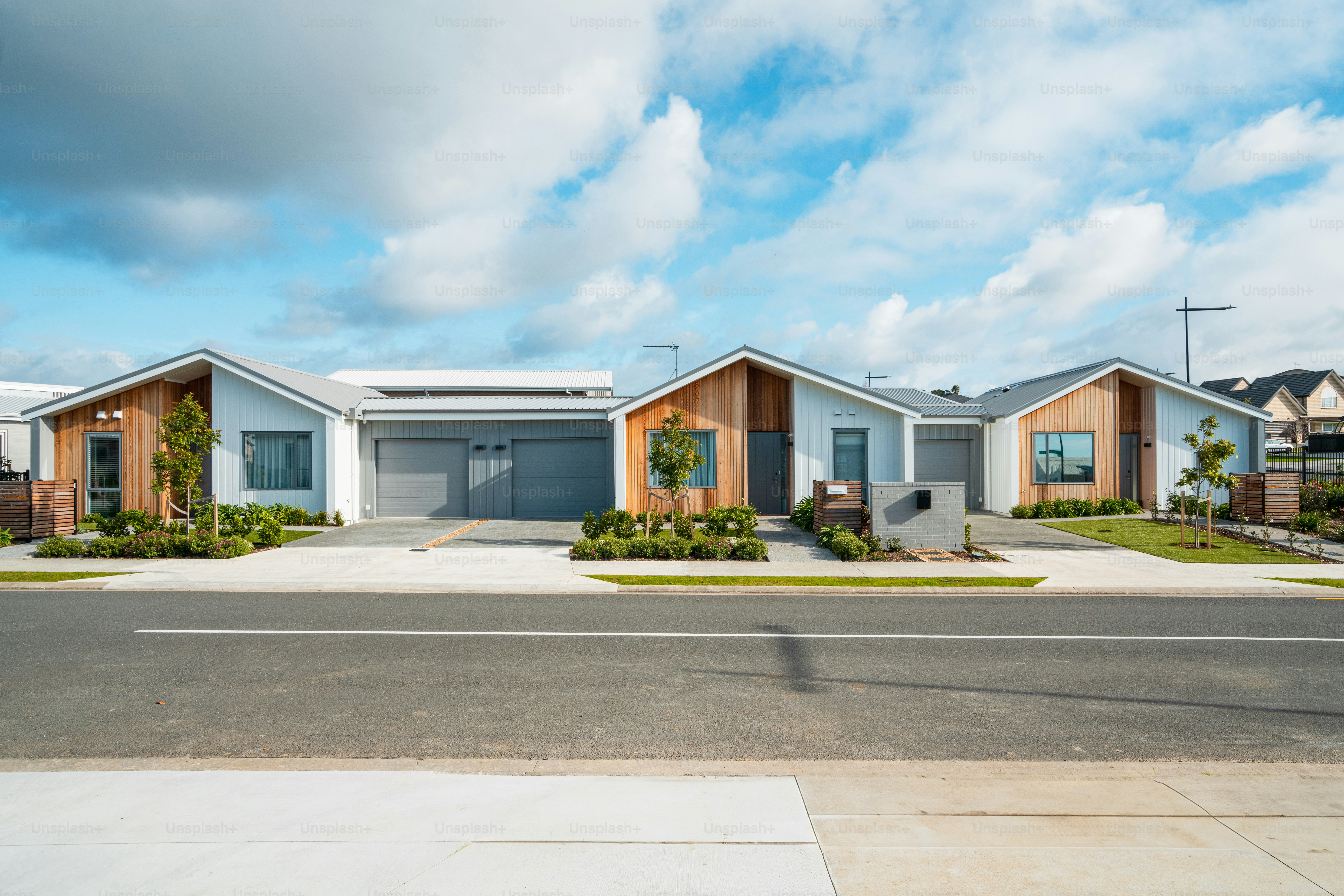 Row of single story newly developed houses side the road. photo – Real ...
