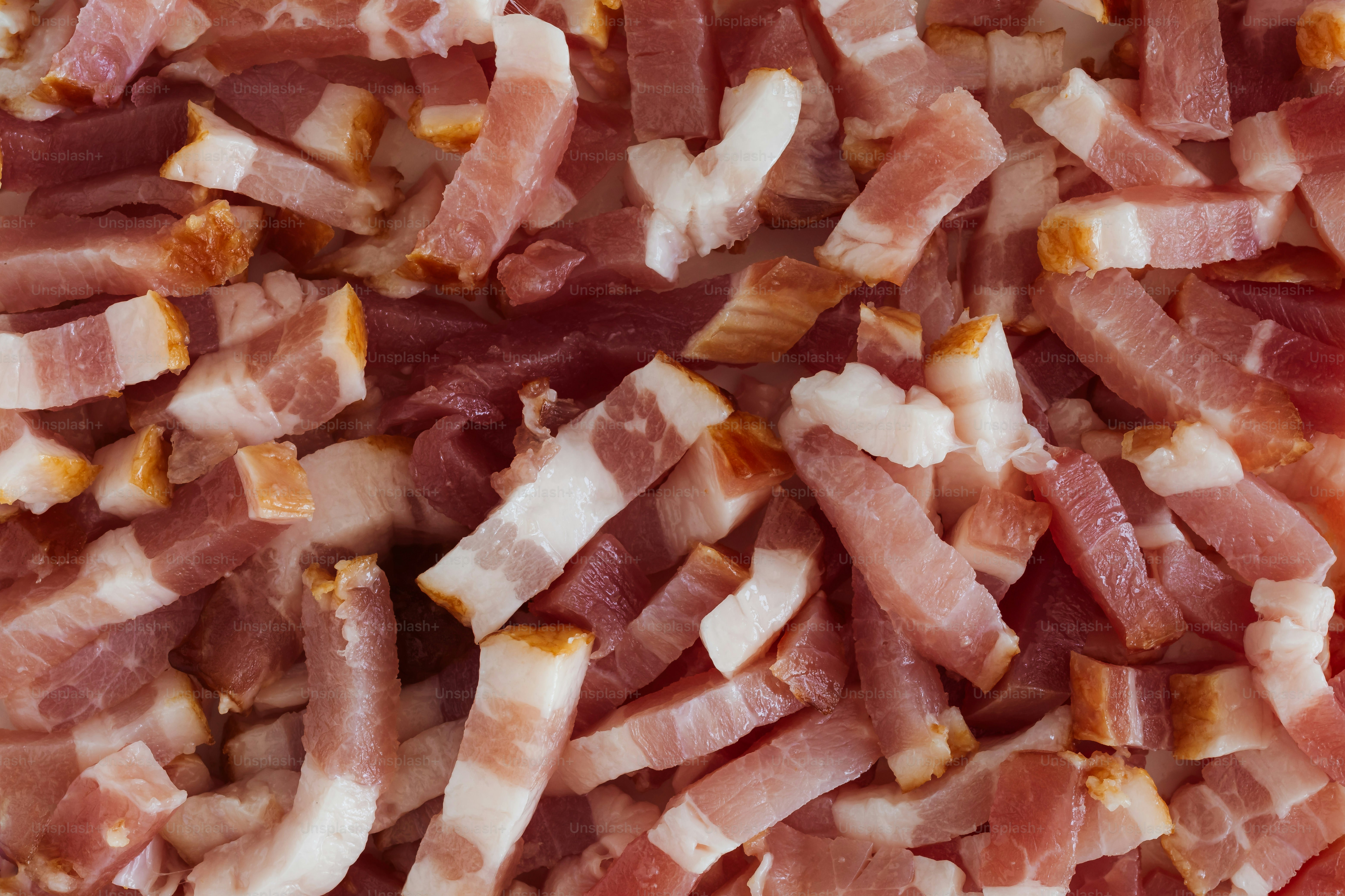 A pile of bacon sitting on top of a table photo – Bacon Image on Unsplash