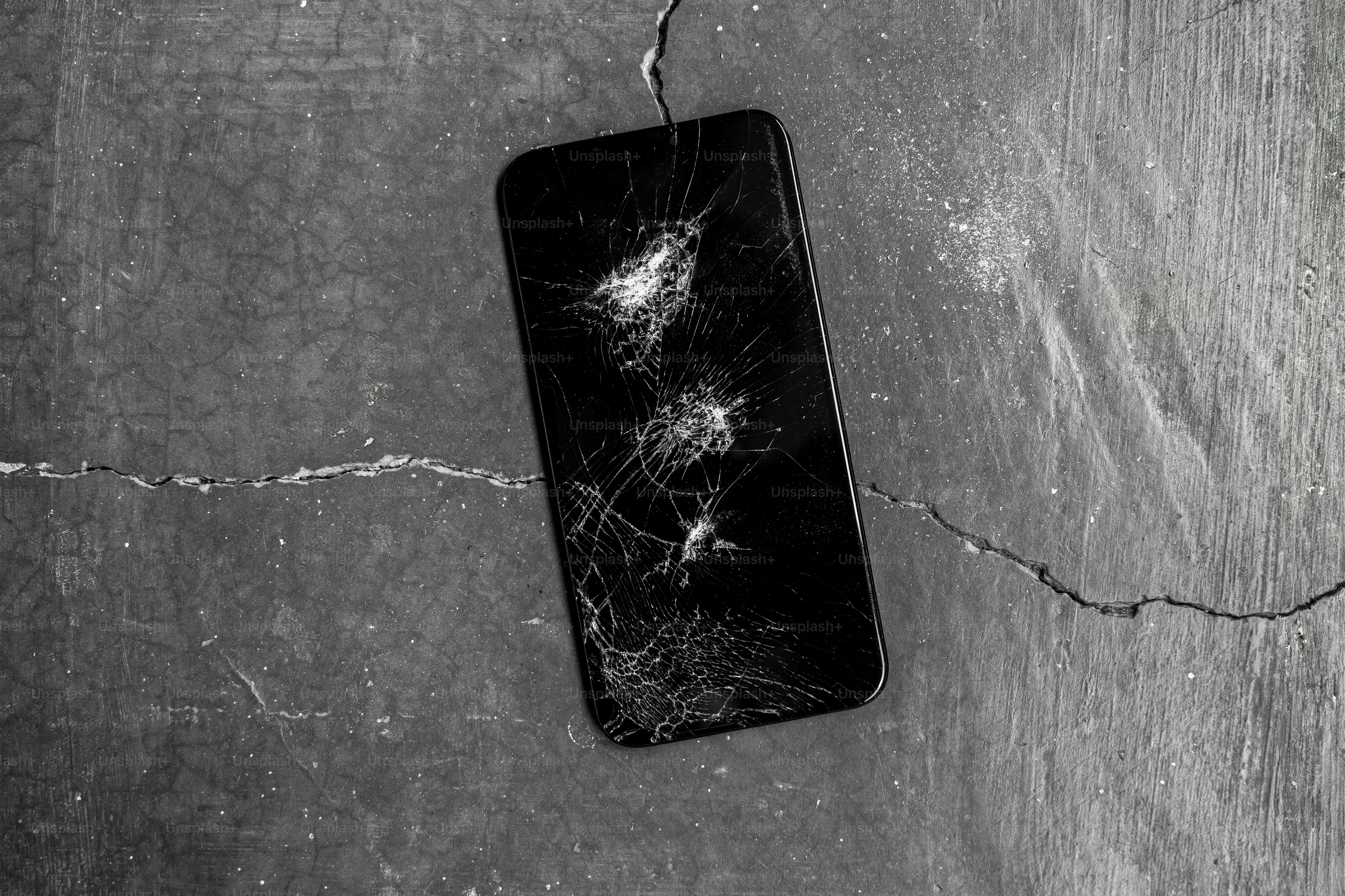A black and white photo of a broken cell phone photo – Broken device ...